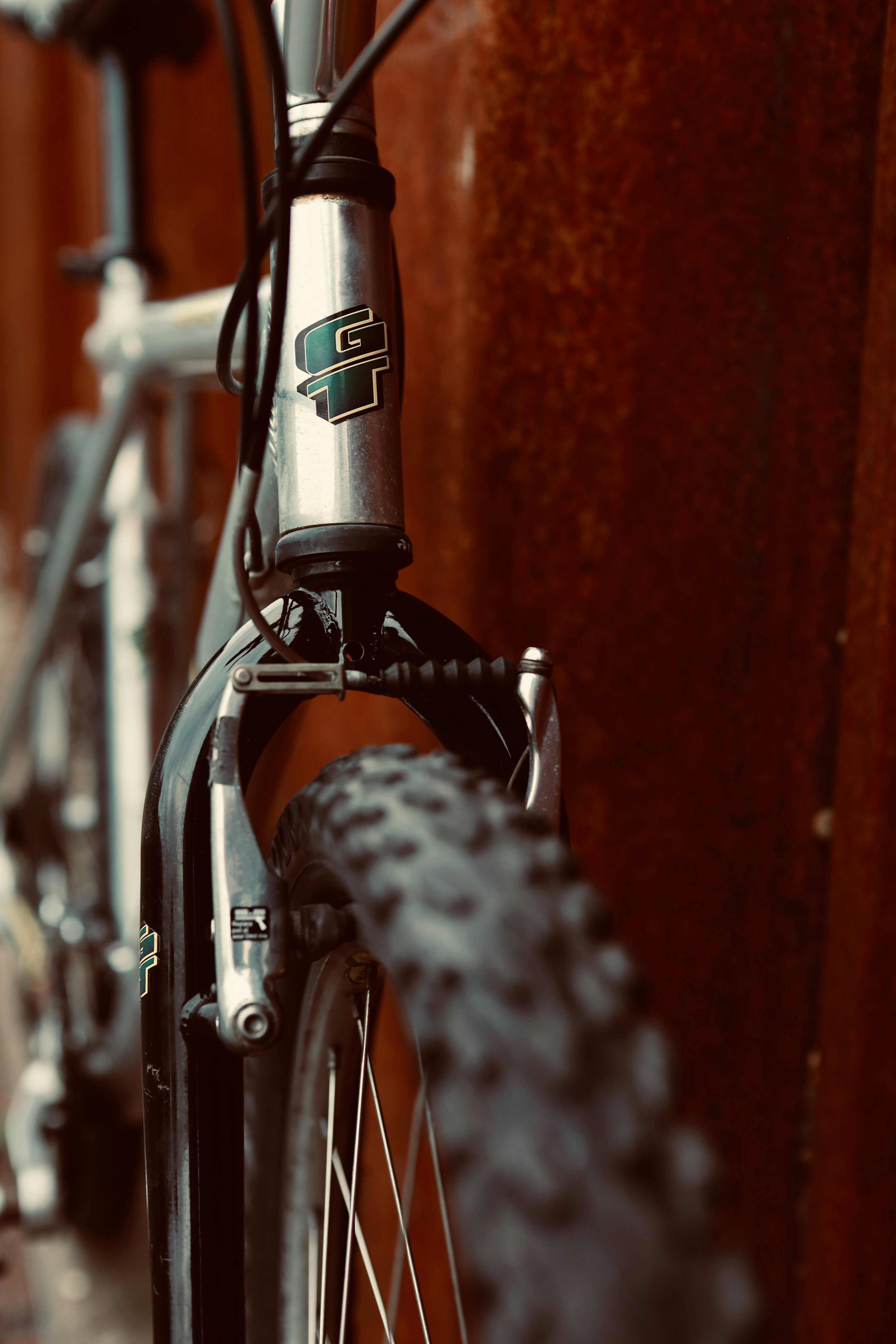 Rust and Ride: A Bicycle Frame Narrowly Framed Against a Weathered Wall