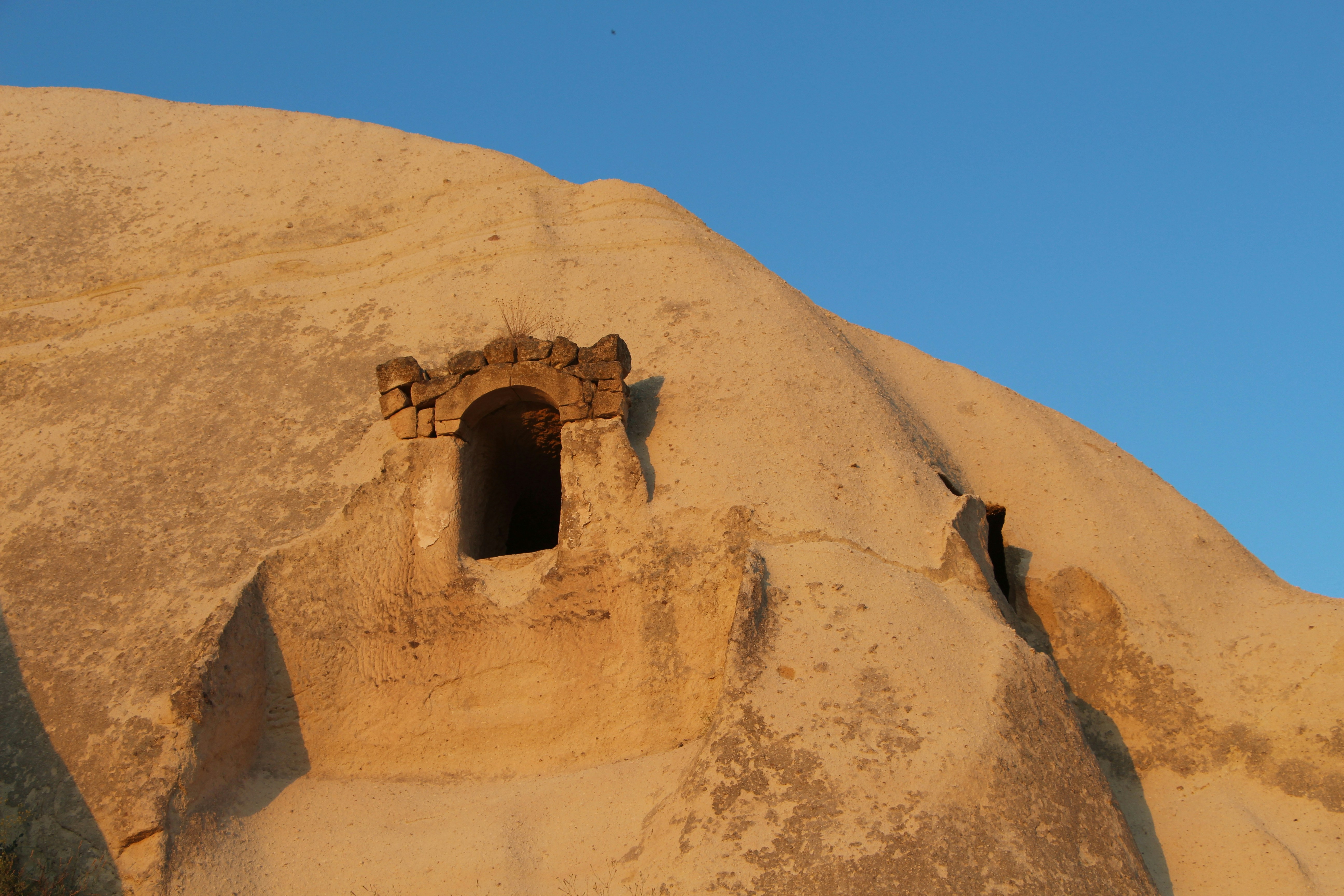 Sunlit cave-like window carved into a dune