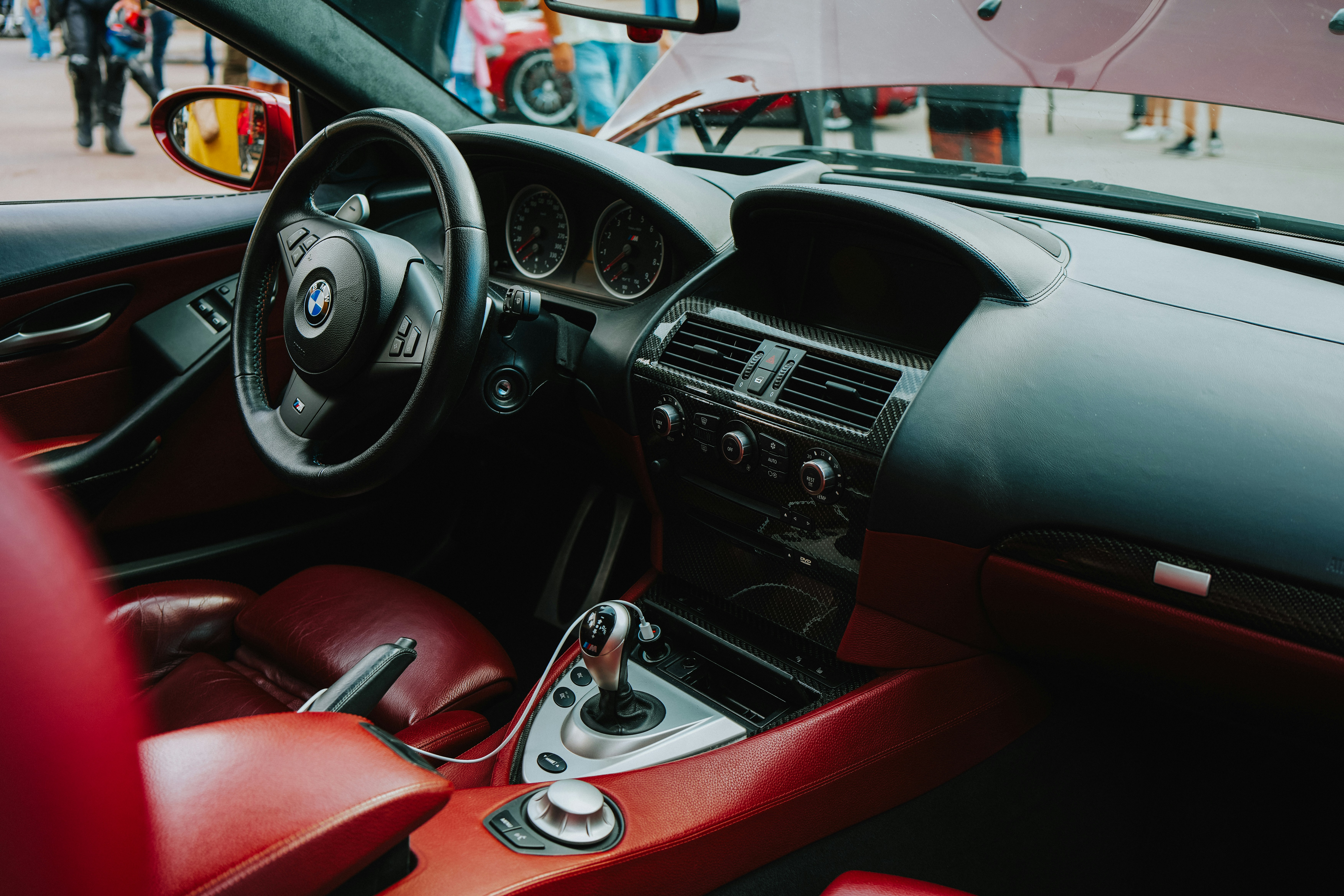 Red cockpit: a BMW’s luxurious focus in a sunlit showroom