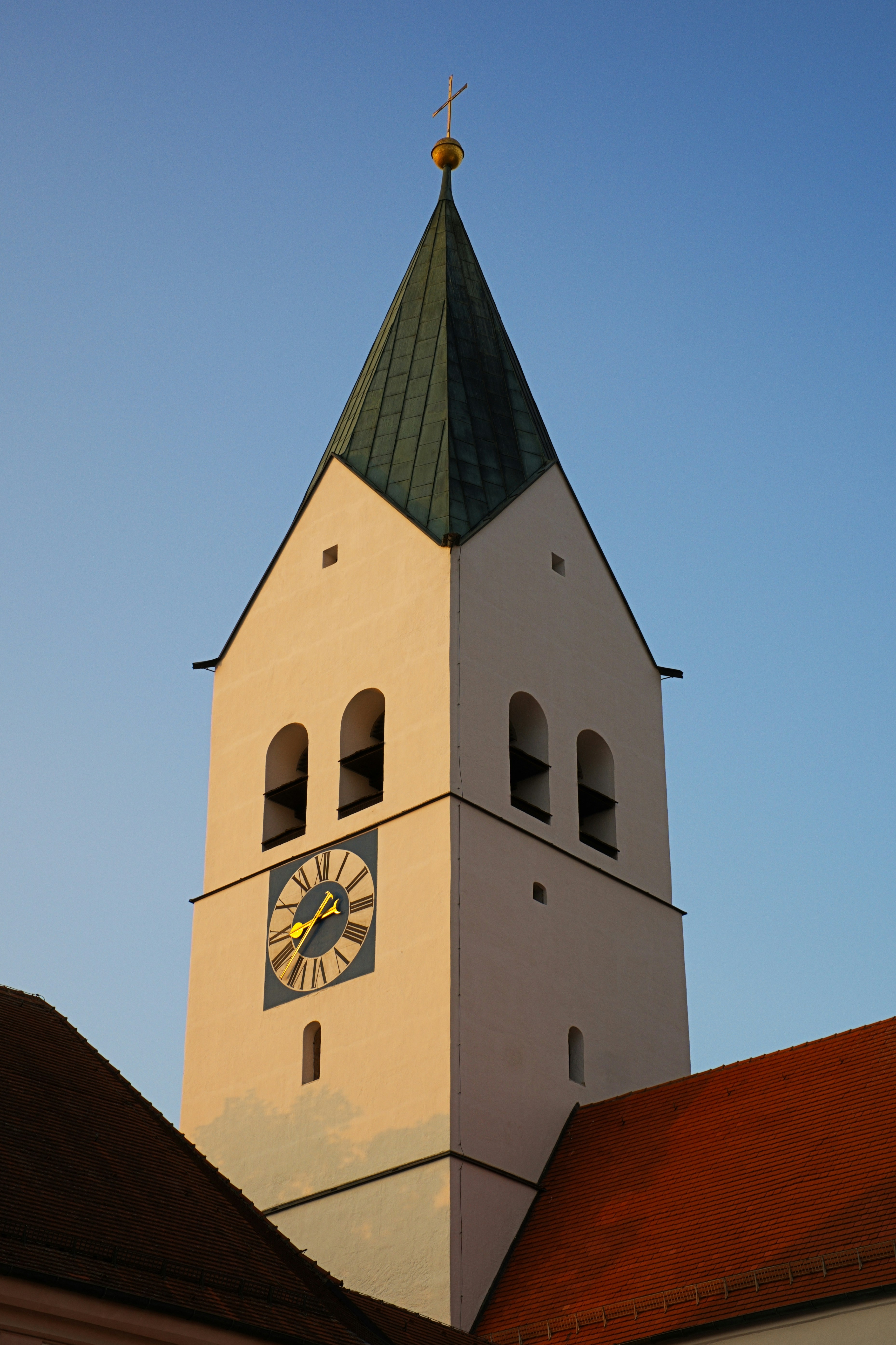 Sunlit Clock Tower Reaching Toward a Clear Sky