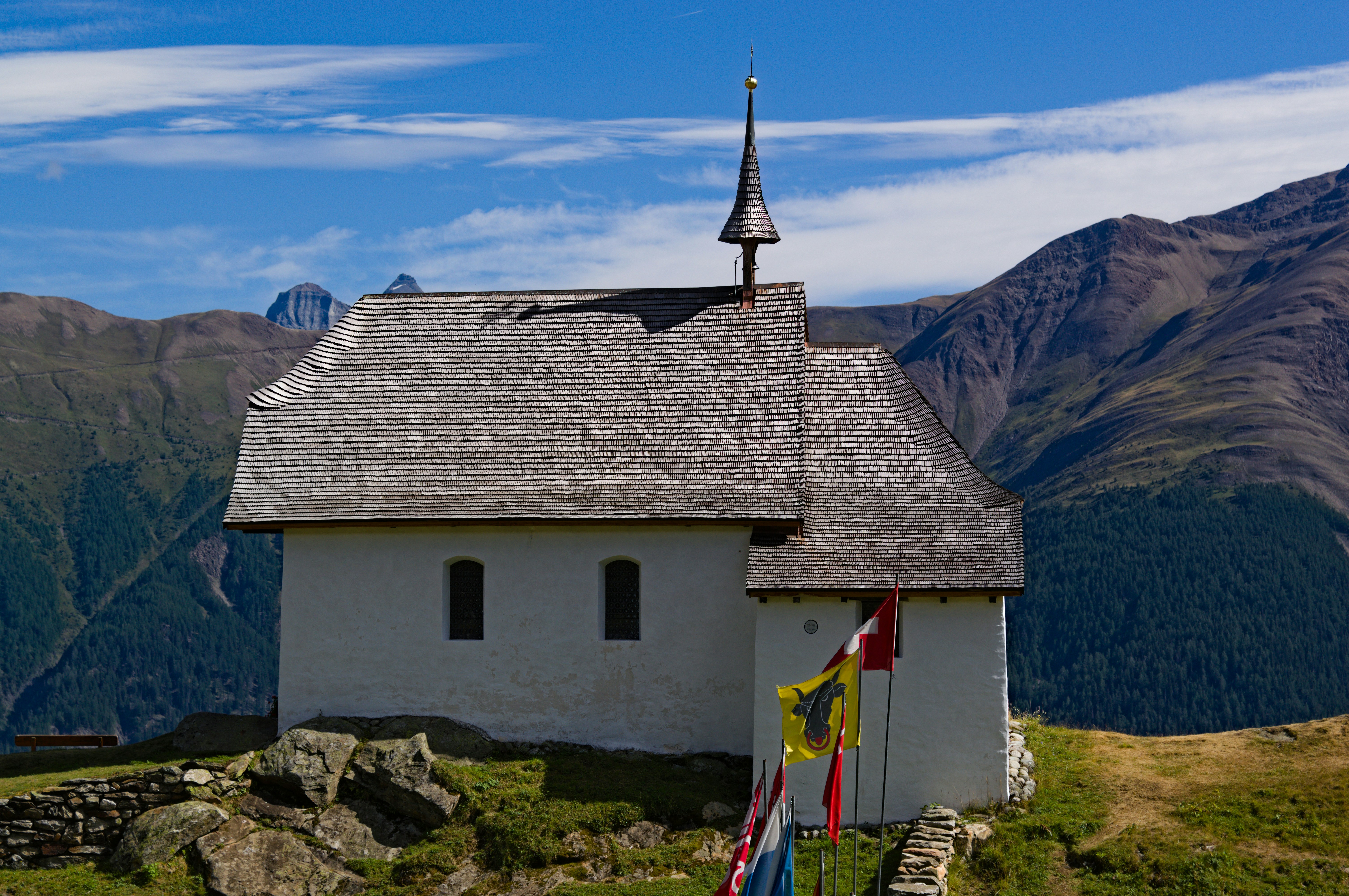 Chalet on the Alpine Ridge Under a Clear Blue Sky