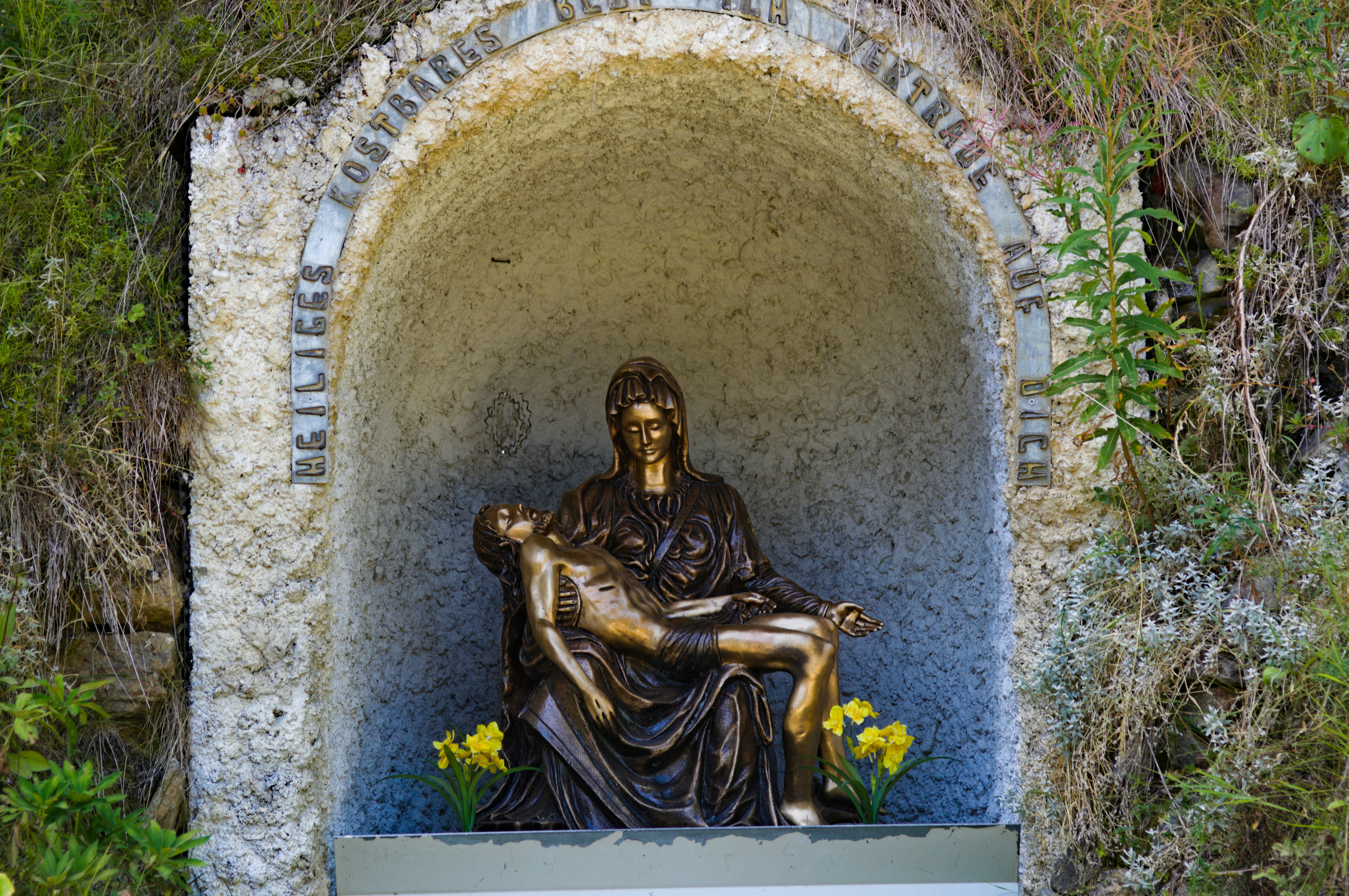 Statue of Mercy: Virgin and Child Cradled in a Stone Niche