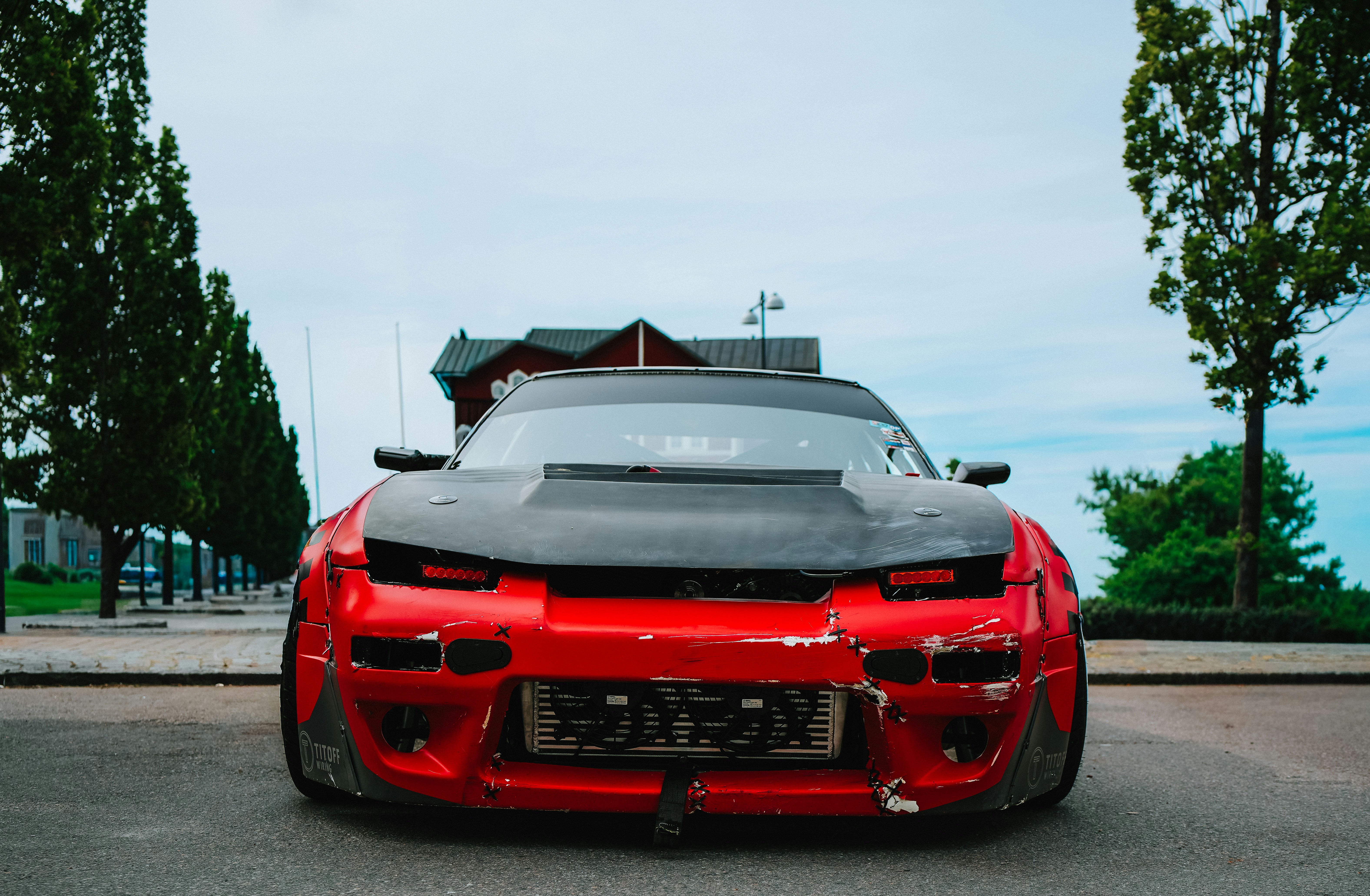 Broken Red Sport: Front-end Scars of a Car Crash