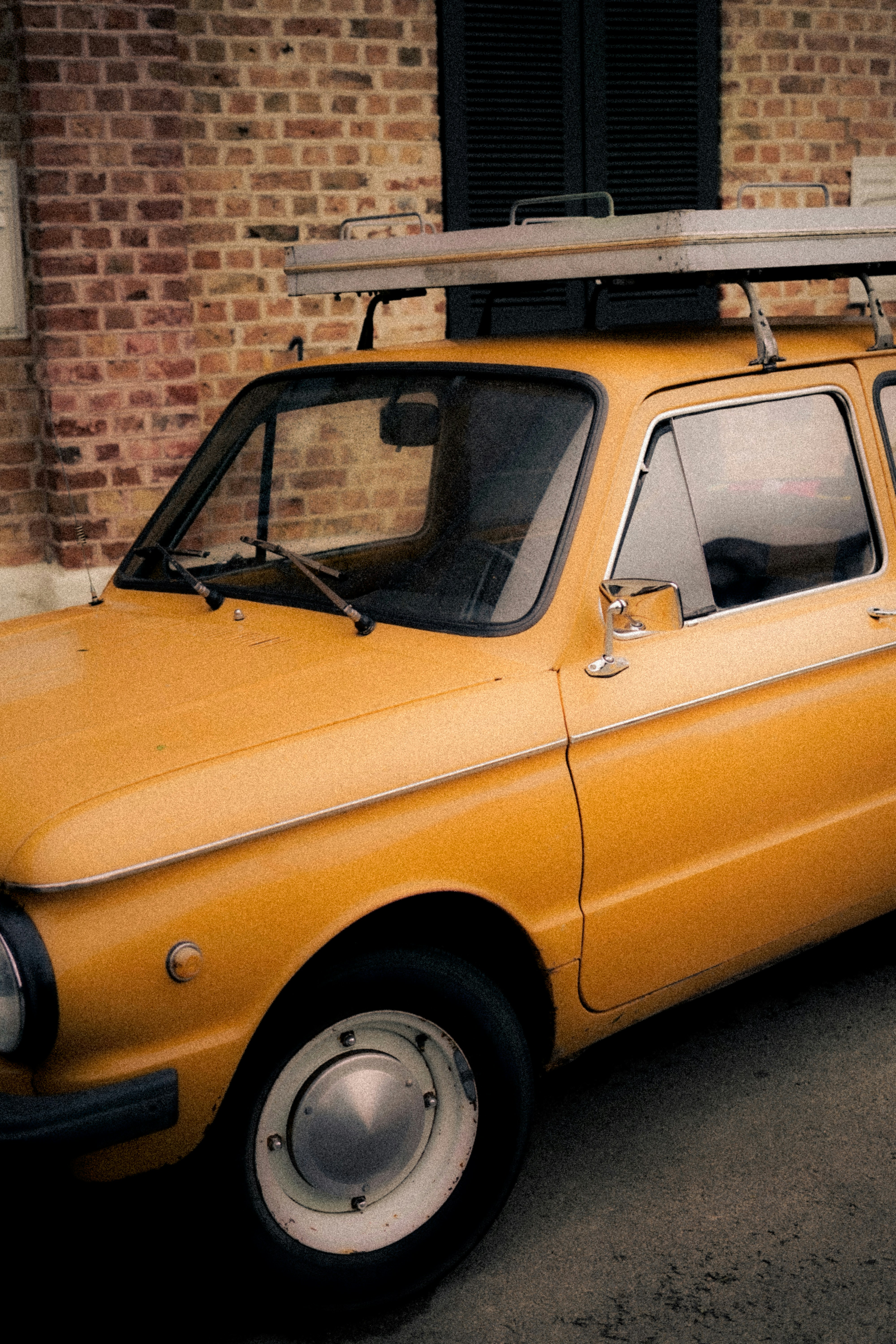 Goldenoldie on the Street: A Vintage Workhorse in Sunlit Brick