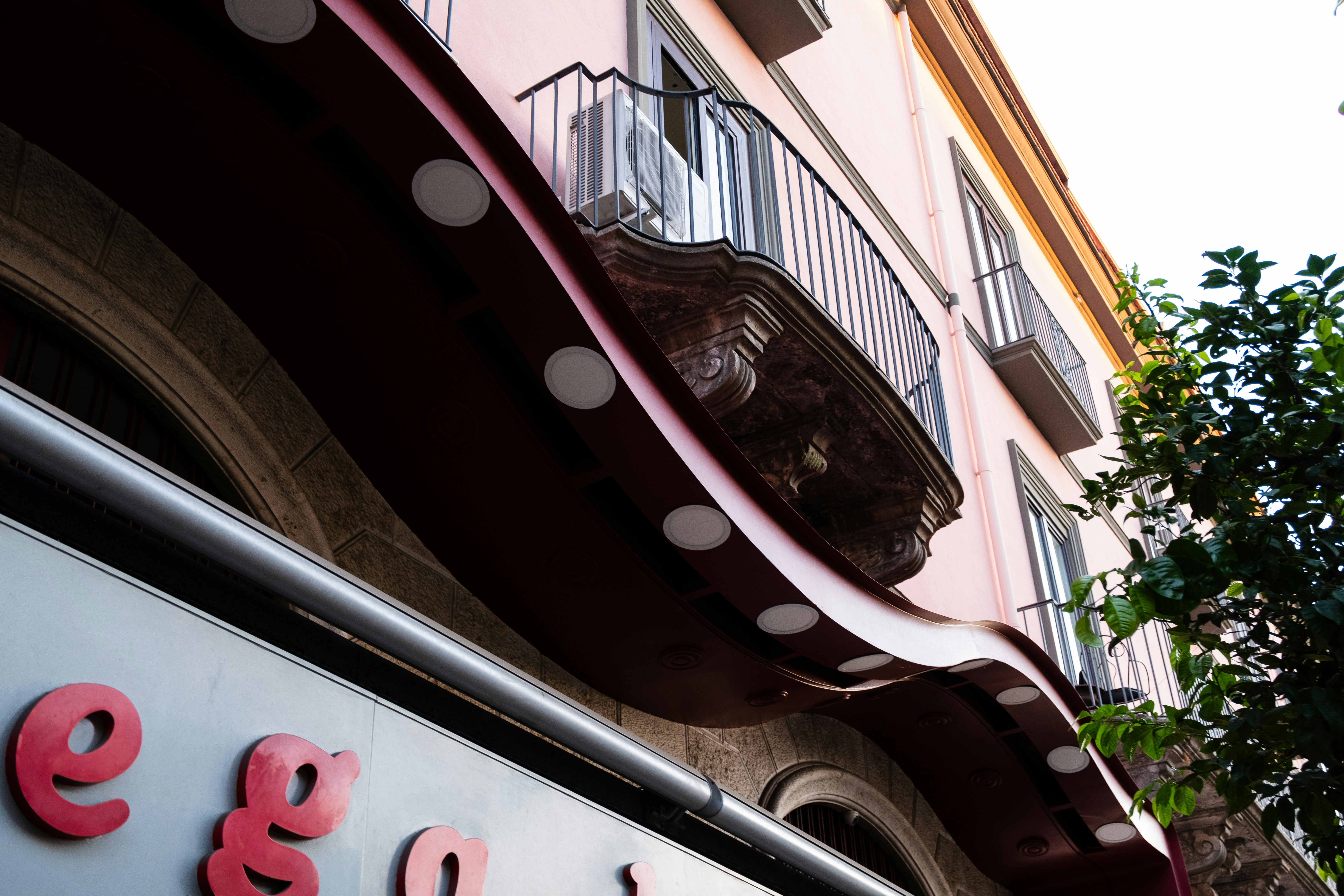 Balcony Curves Over a Neon Sign