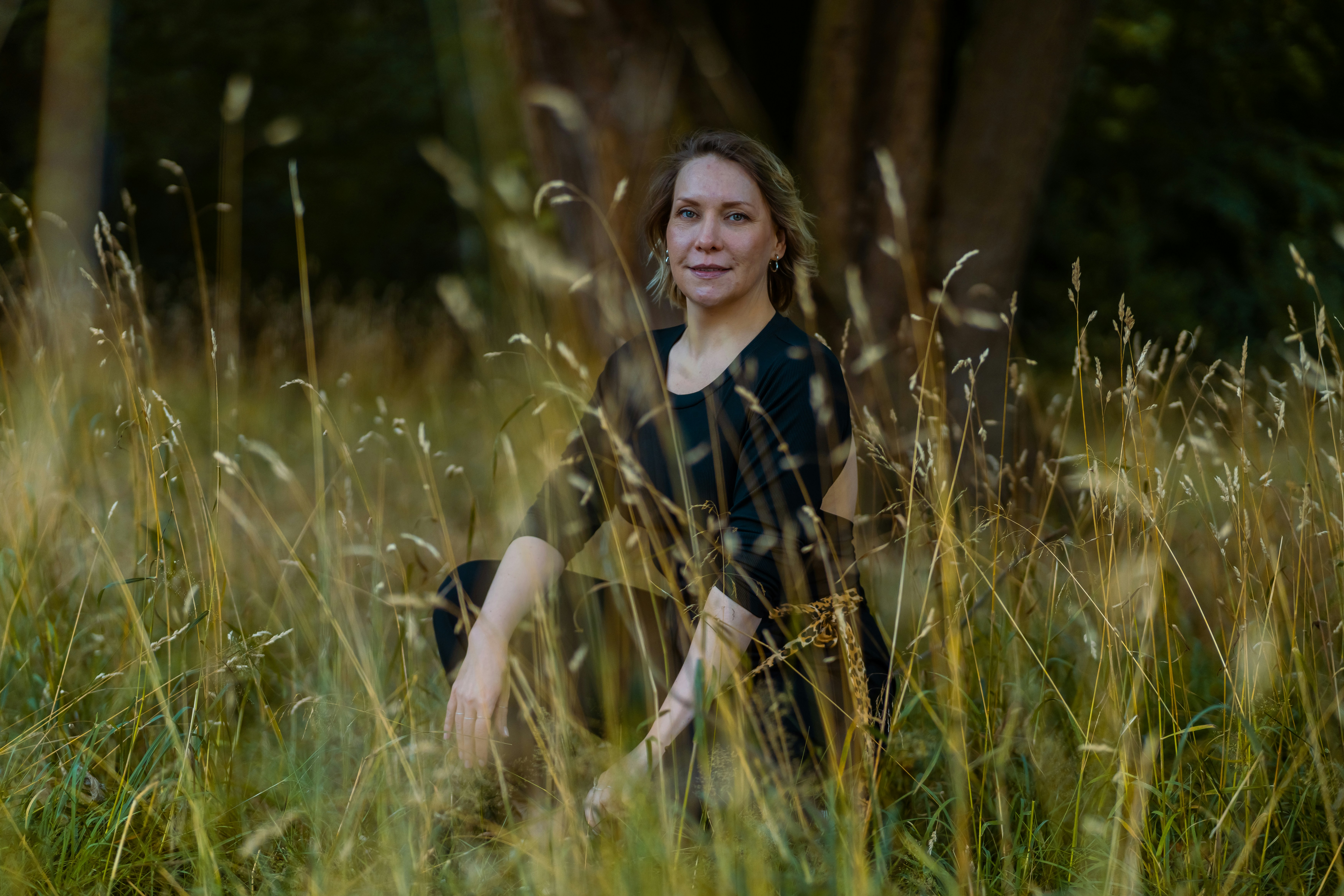 Sunlit Stillness: A Woman in Tall Grass