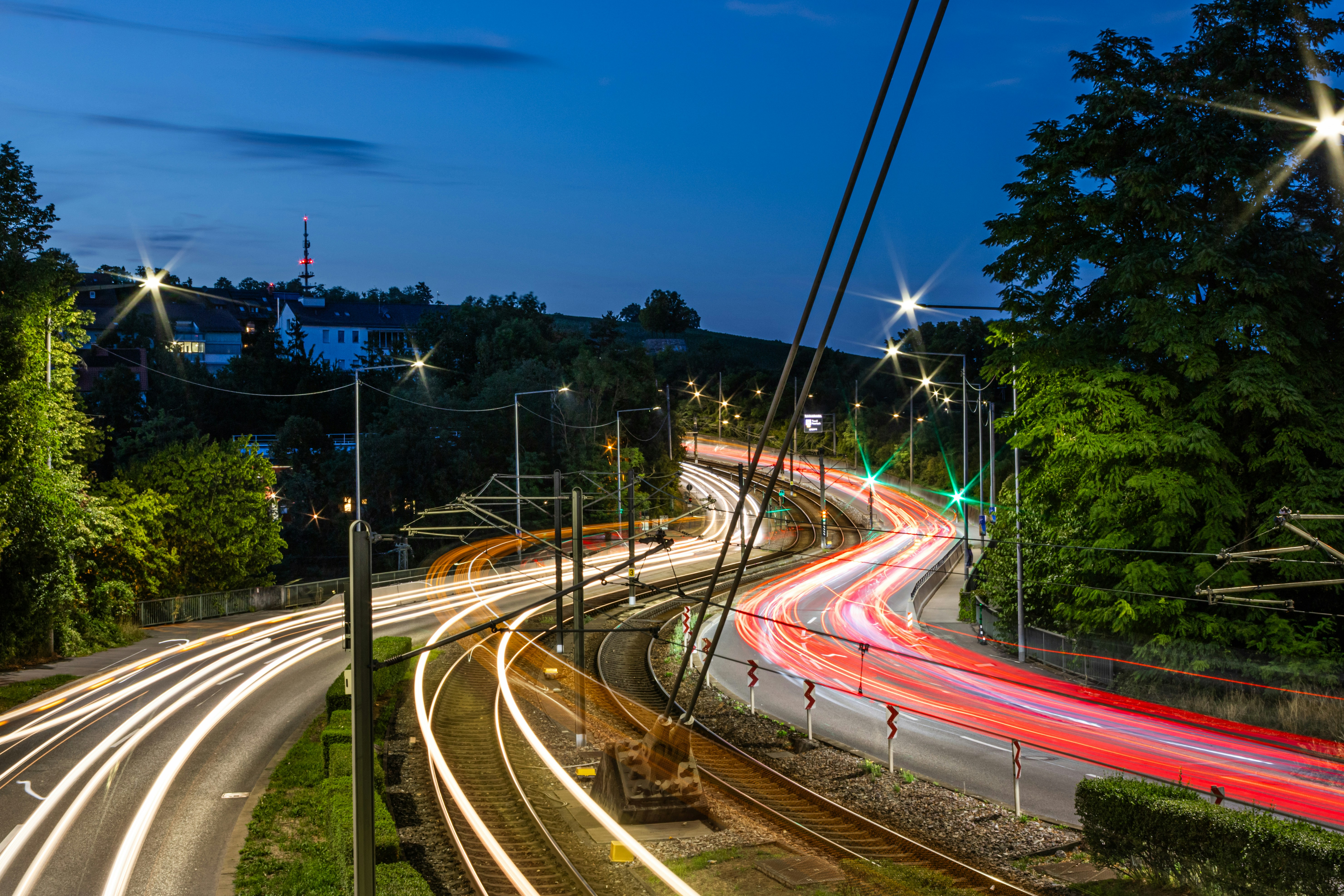 Neon River of Light: A Nighttime Rail Vein Through the Suburban Spine