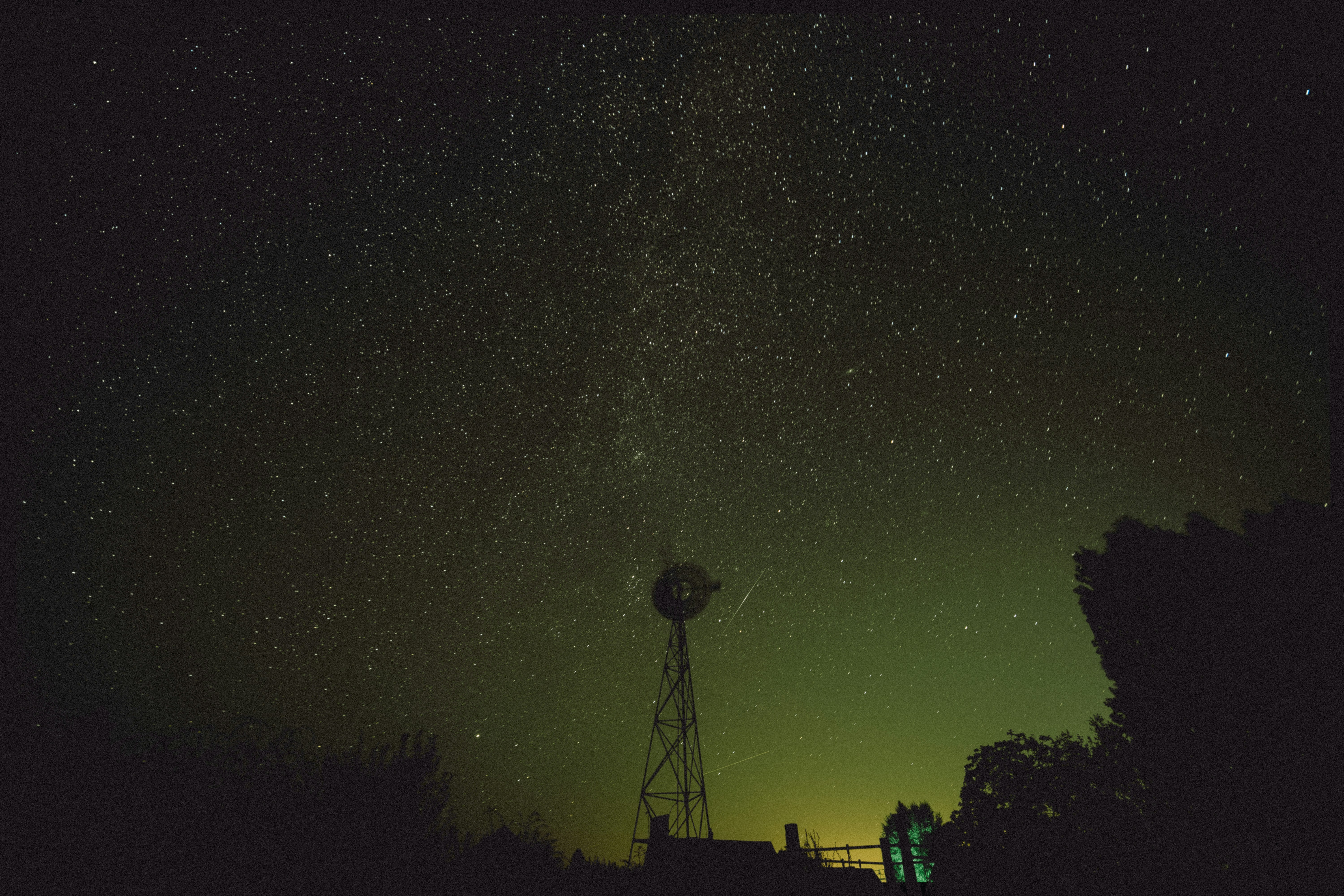 Stars over the Silhouette: A Night Sky with a Wind Tower