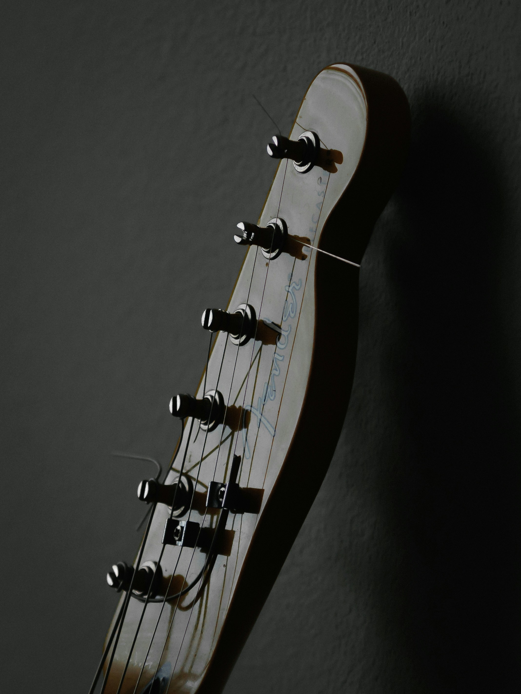 Angled Guitar Headstock in Moody Lighting