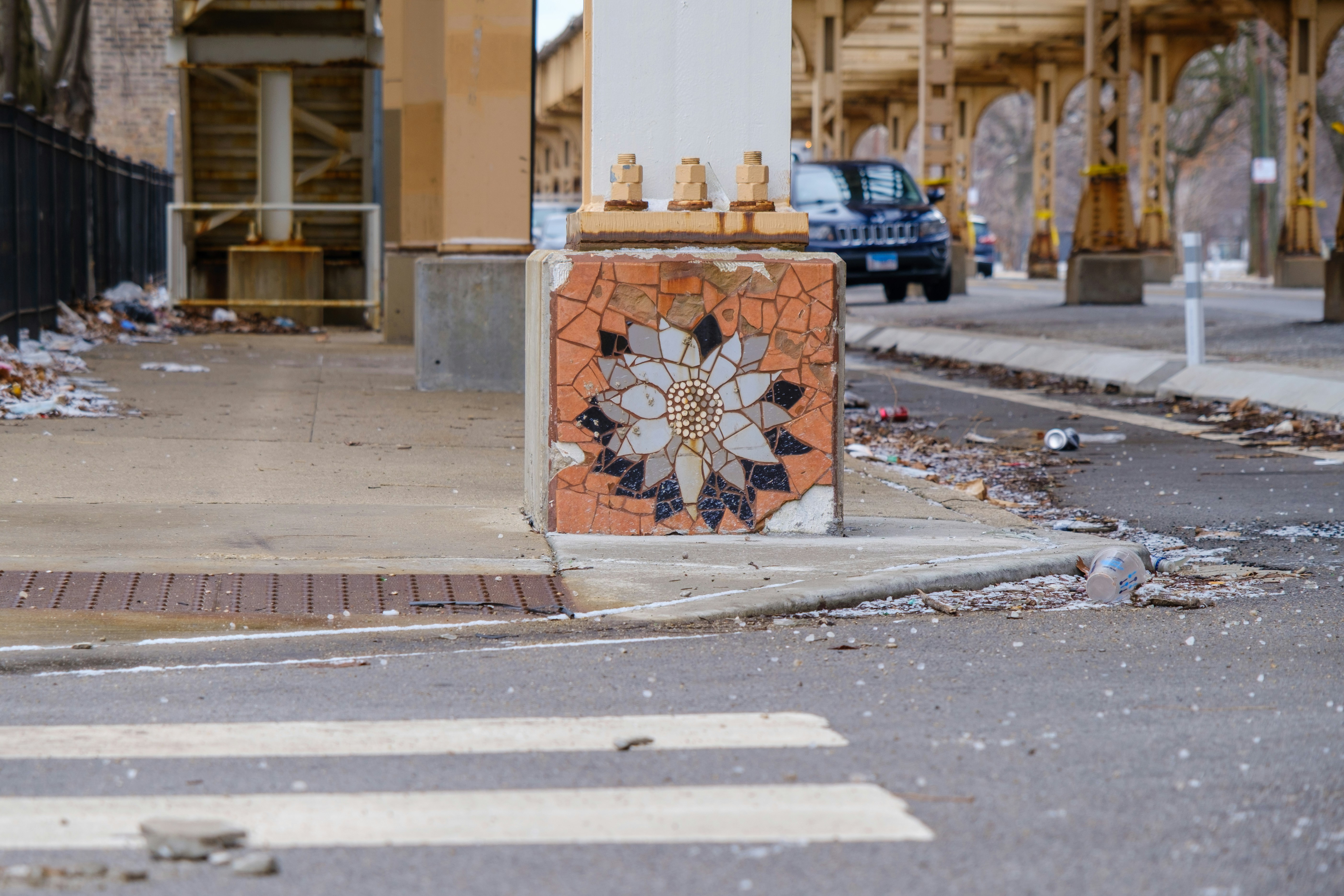 Mosaic Column Amid a Quiet, Dizzying Street