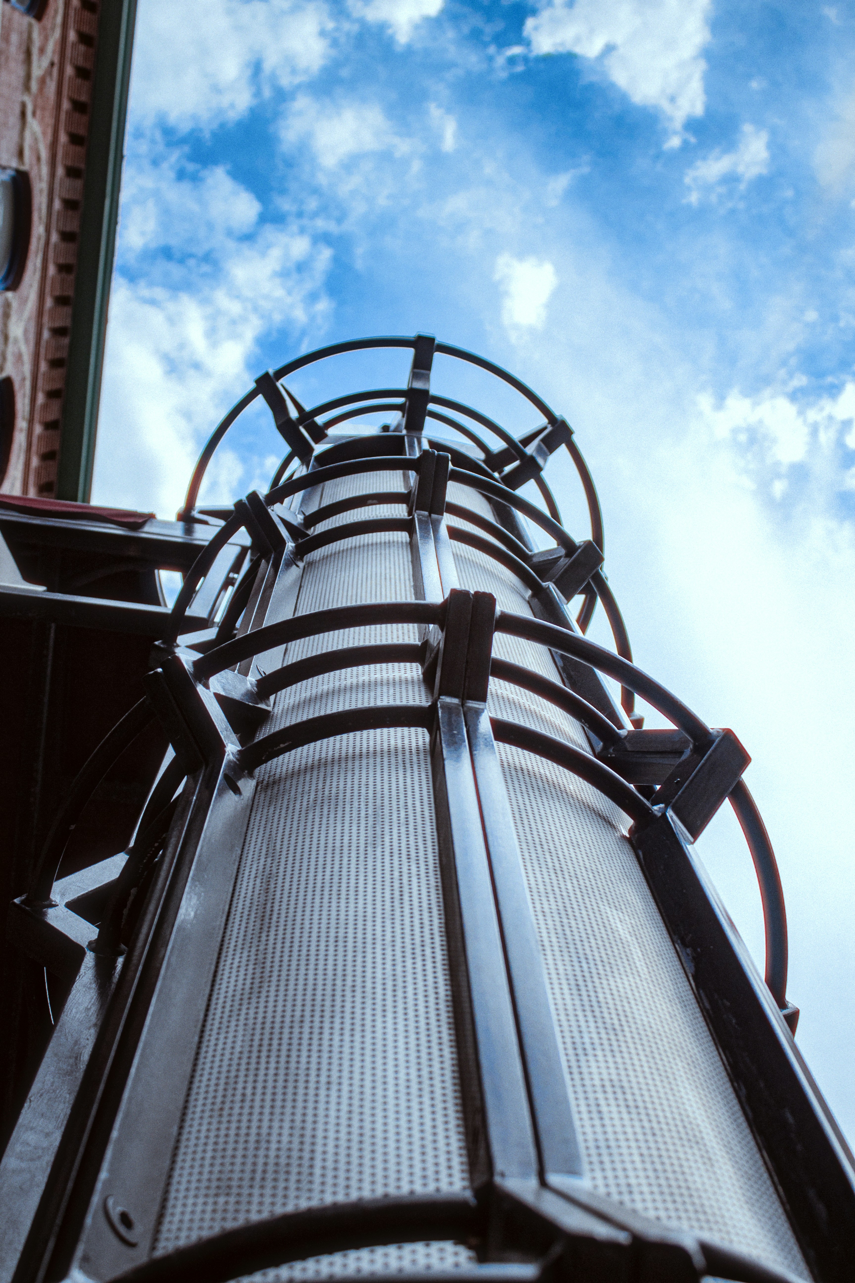 Industrial Helix Ascending: A Close-Up of a Metal Support Tower Against a Sky
