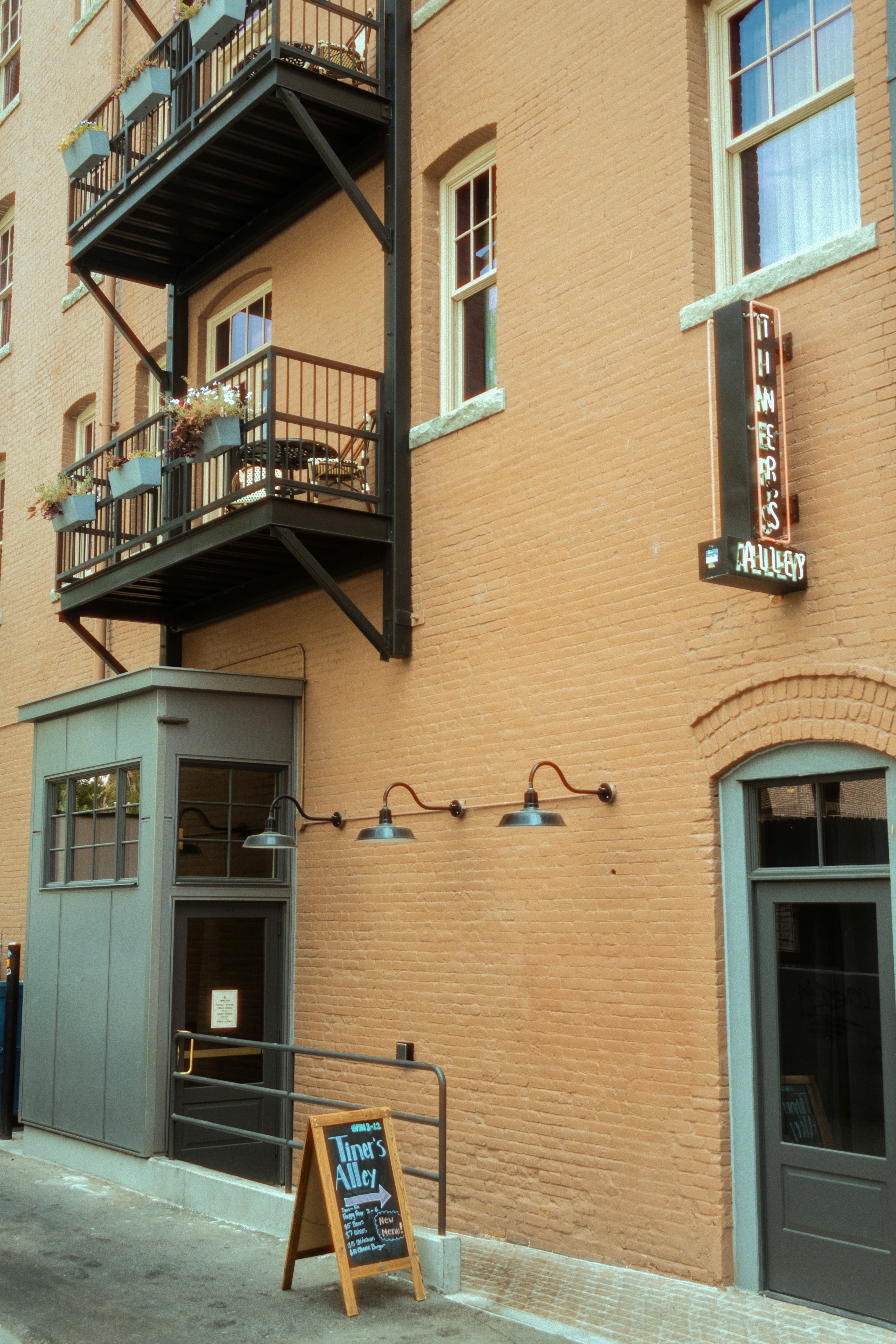 Brick Street Atelier: Neon Sign and Balcony Calm