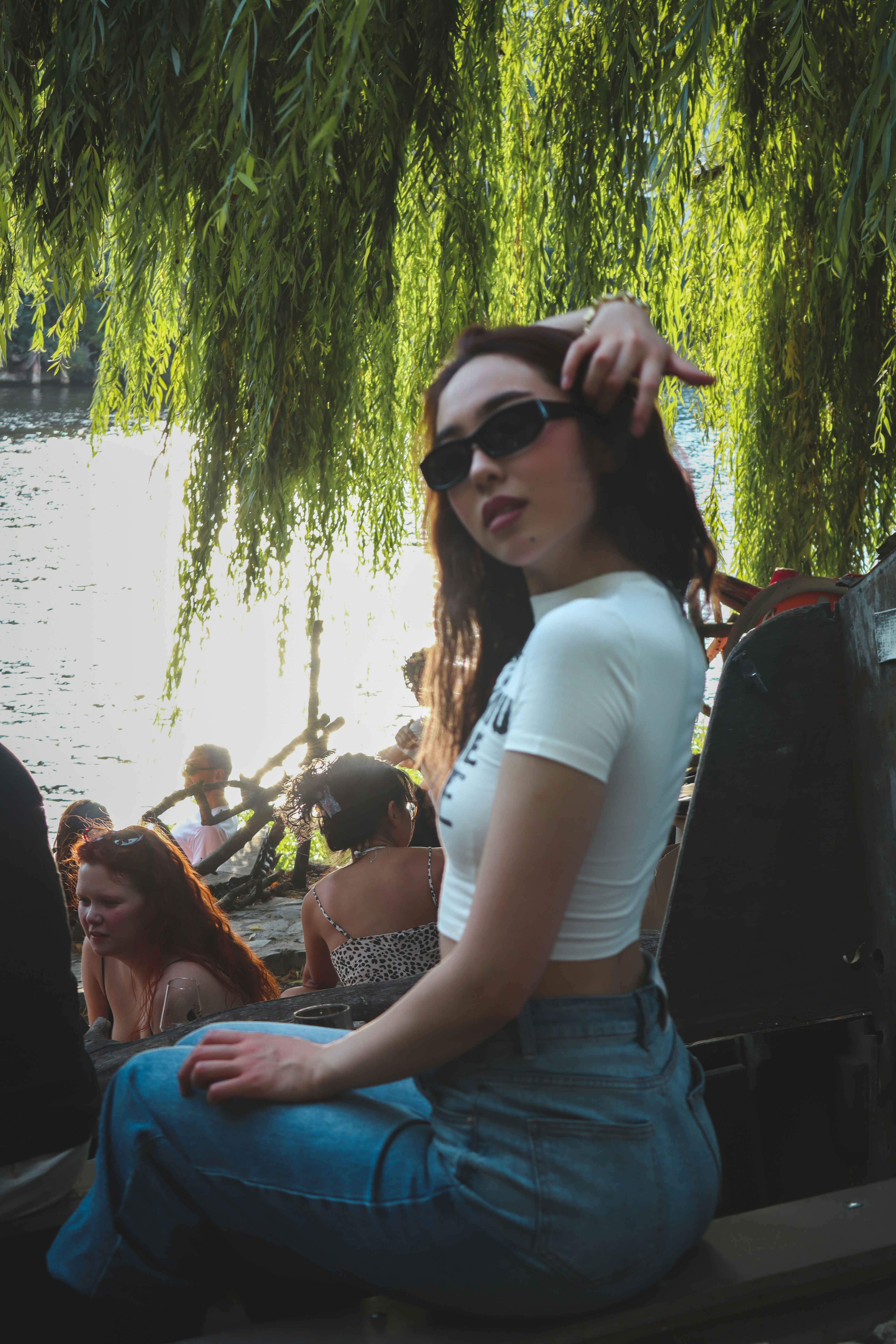 Sunlit Snapshot by the Riverside: Confident Portrait Under Willow Shade