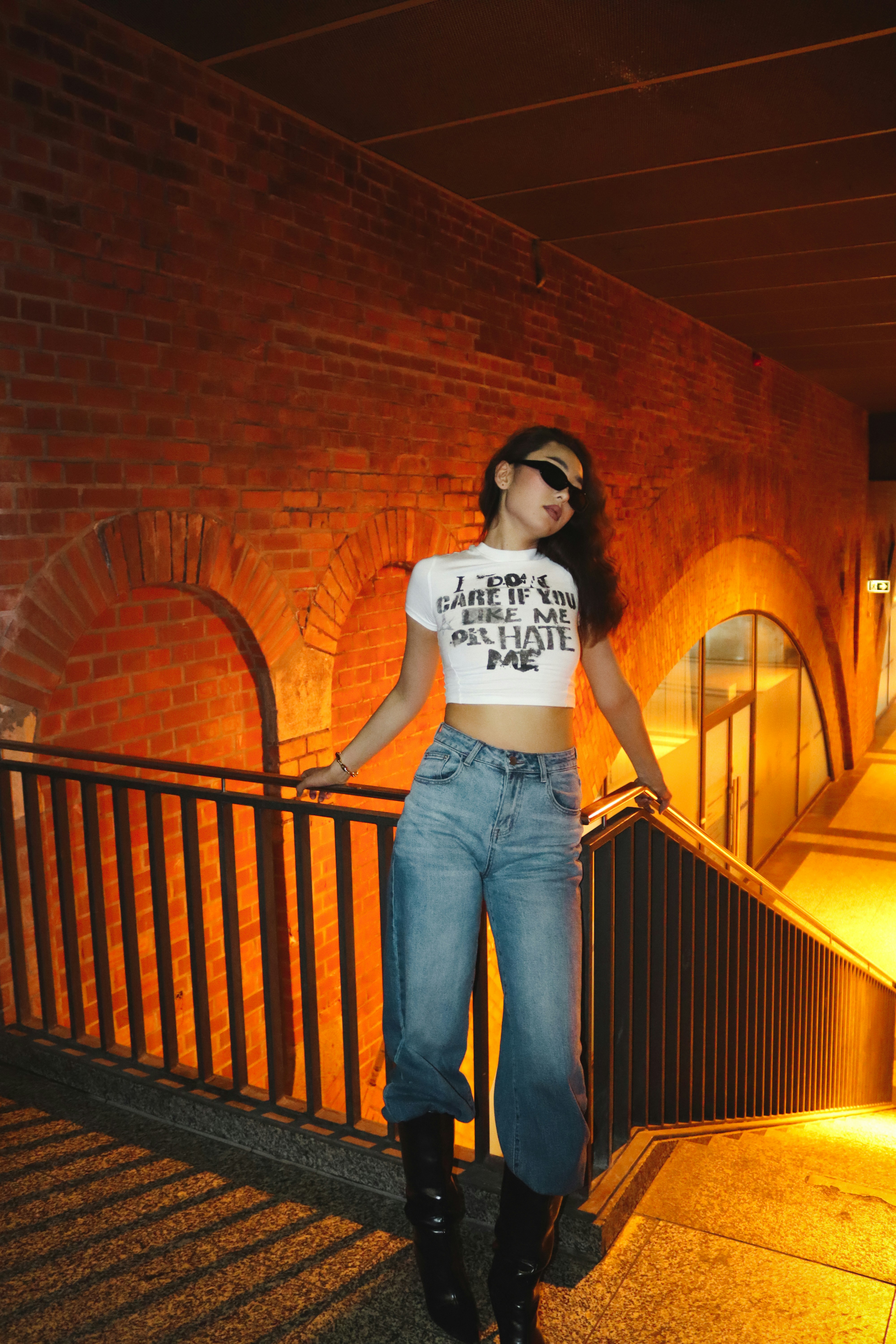 Urban Glow: Jeans, Boots, and Nighttime Brickwork