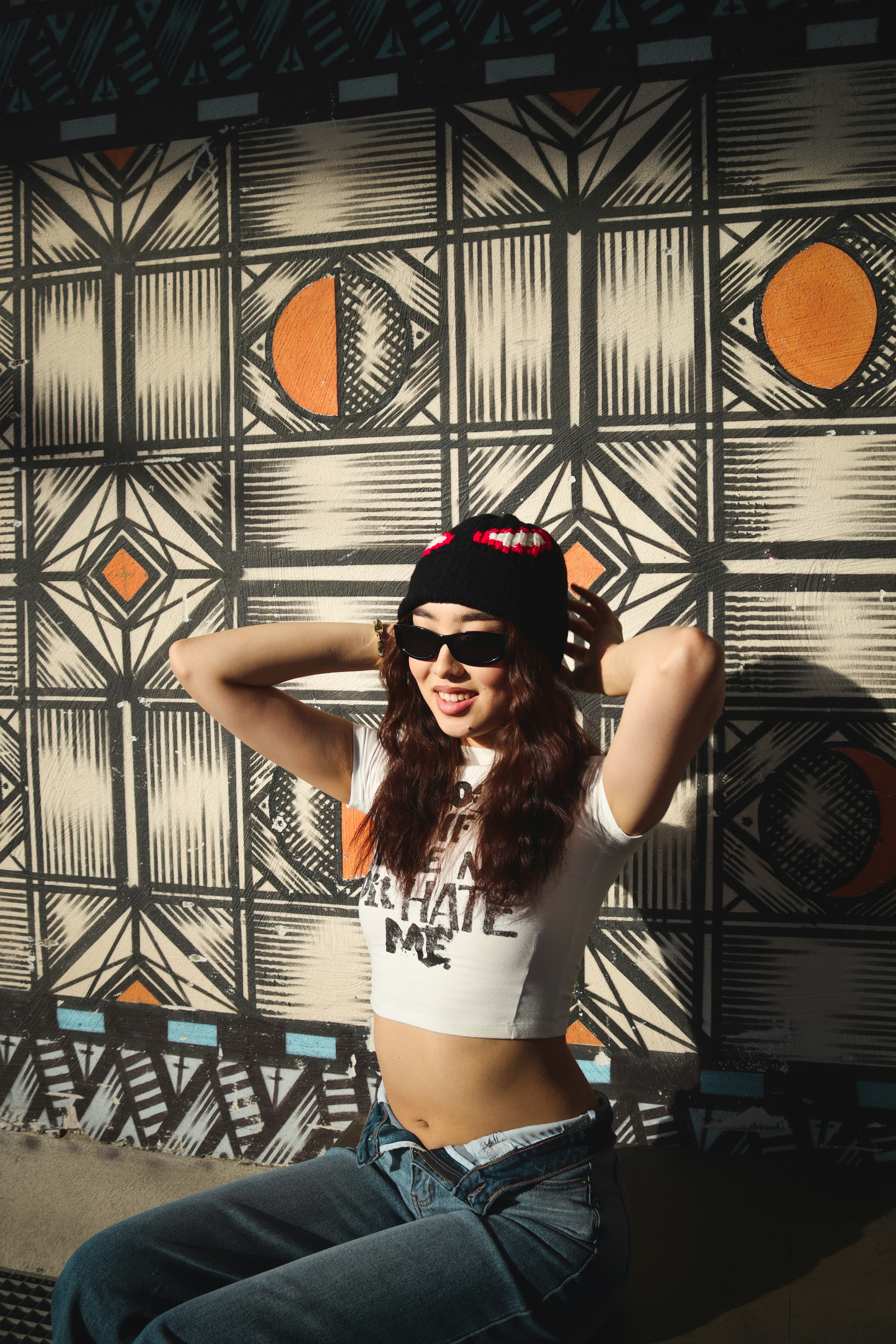 Sunlit Street Portrait with Geometric Graffiti Backdrop