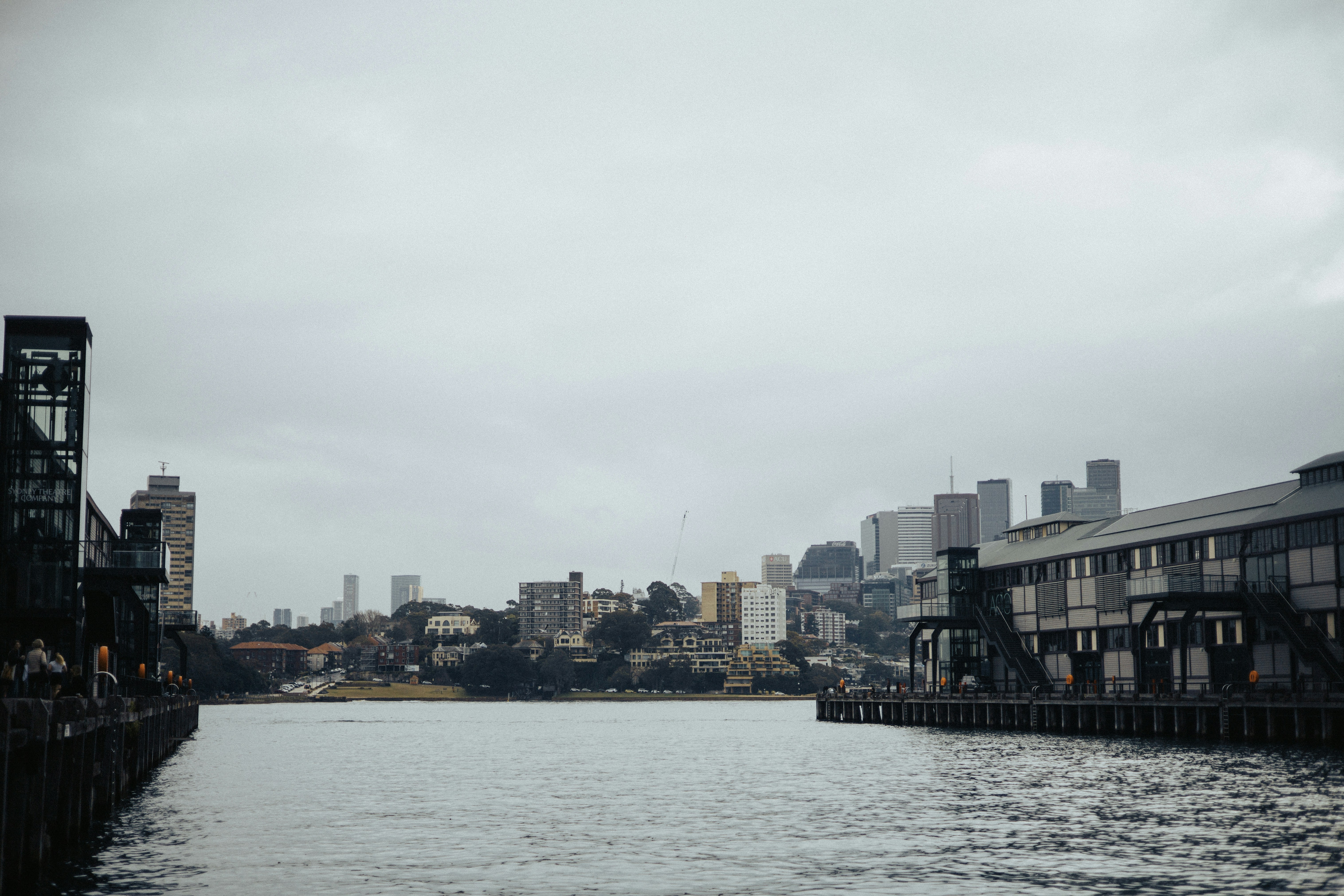 Harbor Edge: City Skyline Framed by Waterfront Structures
