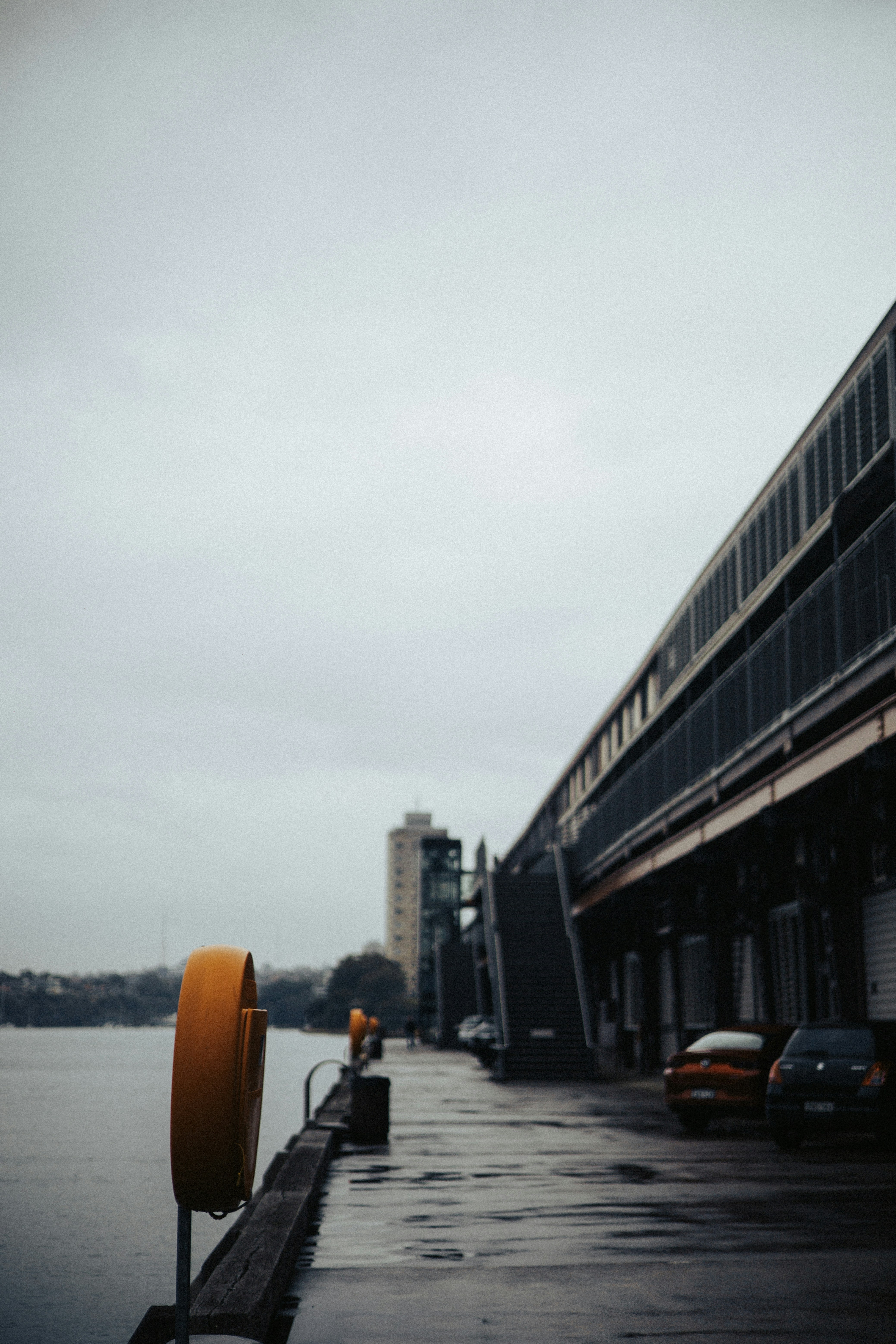 Orange Lifebuoy at the Waterfront: A Quiet Dockside Moment