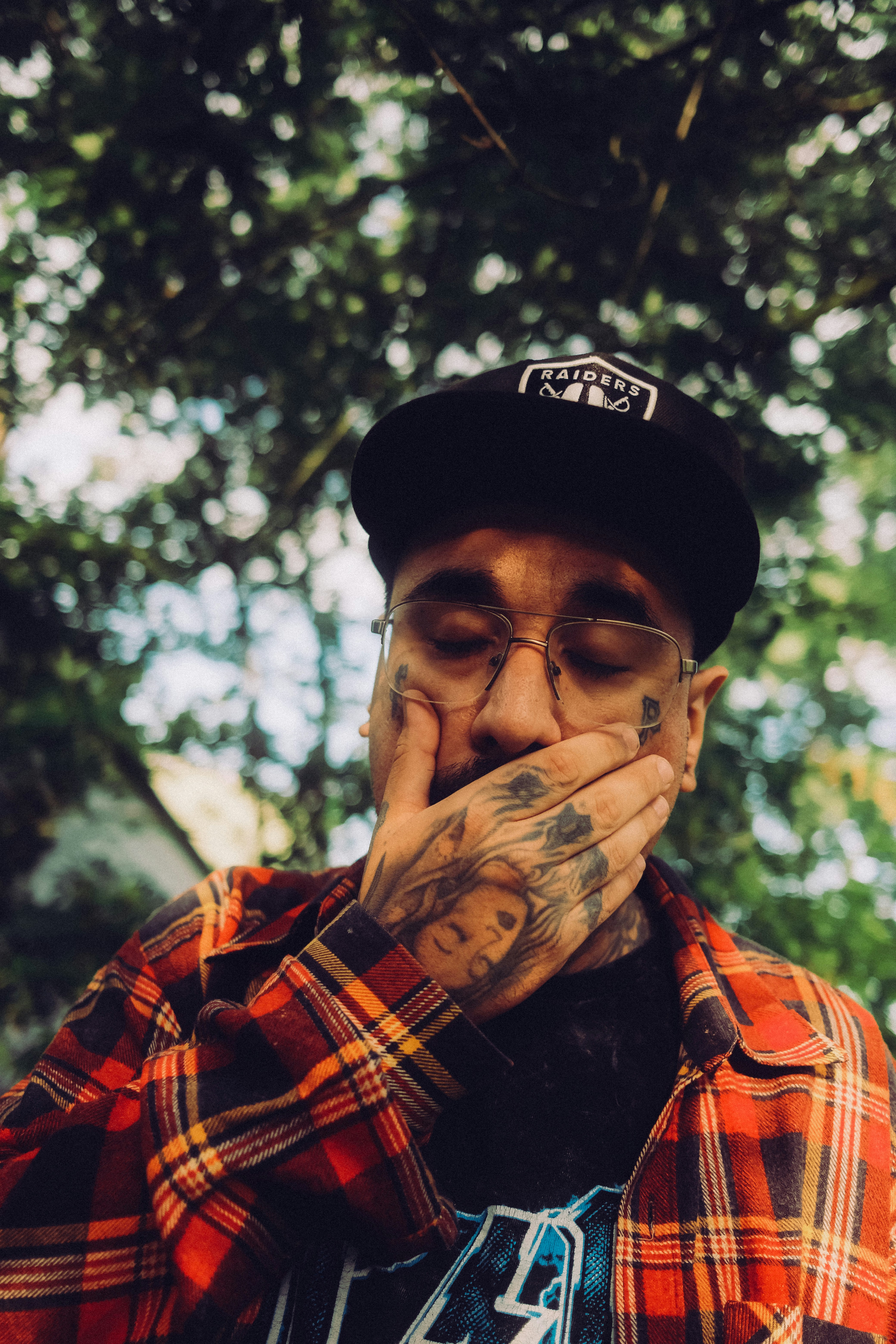 Muted Confidence: A Tattooed Hand Cloaks a Contemplative Moment