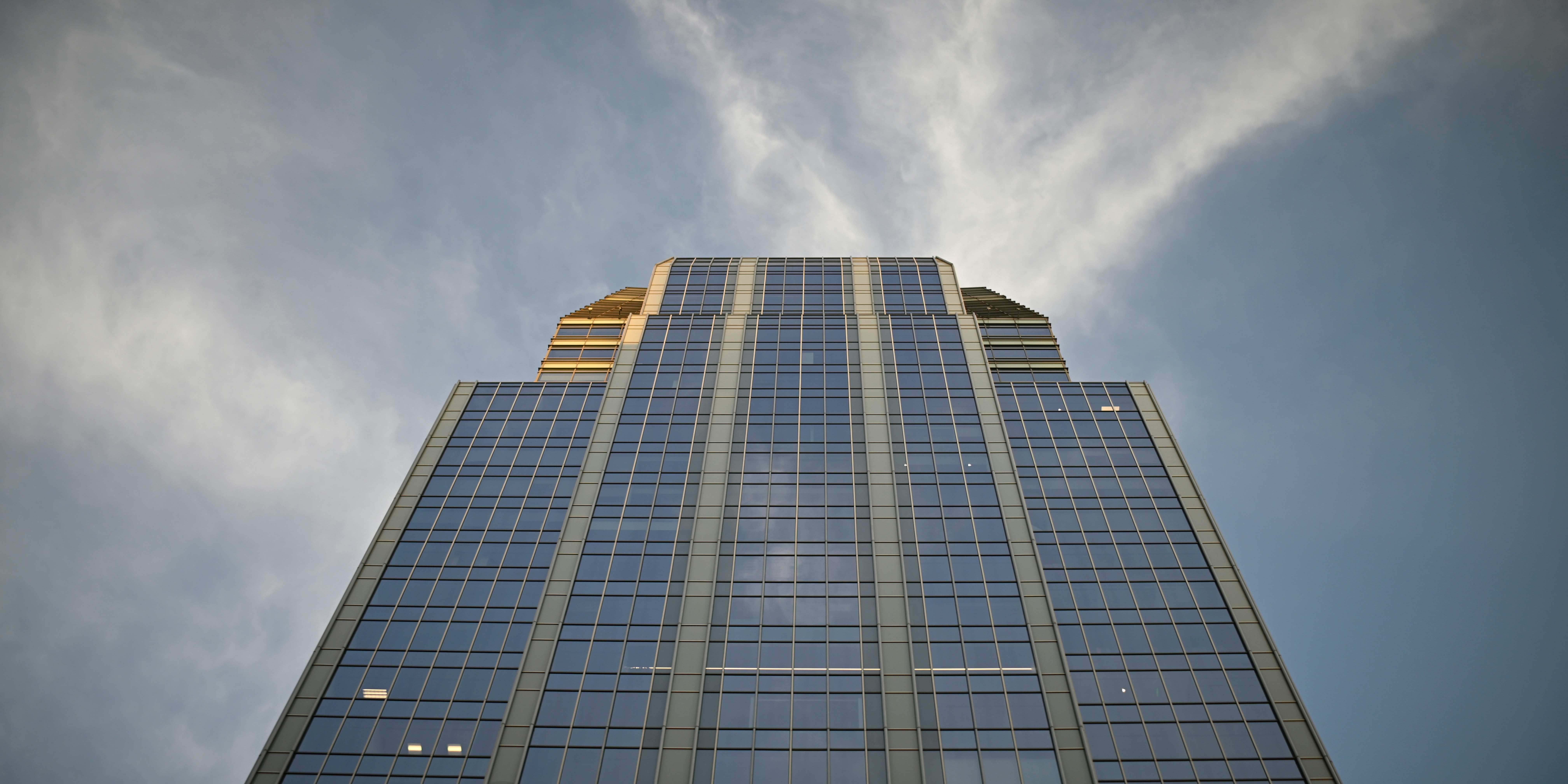 Cloud-tinged Tower Reaching Toward an Expanding Sky