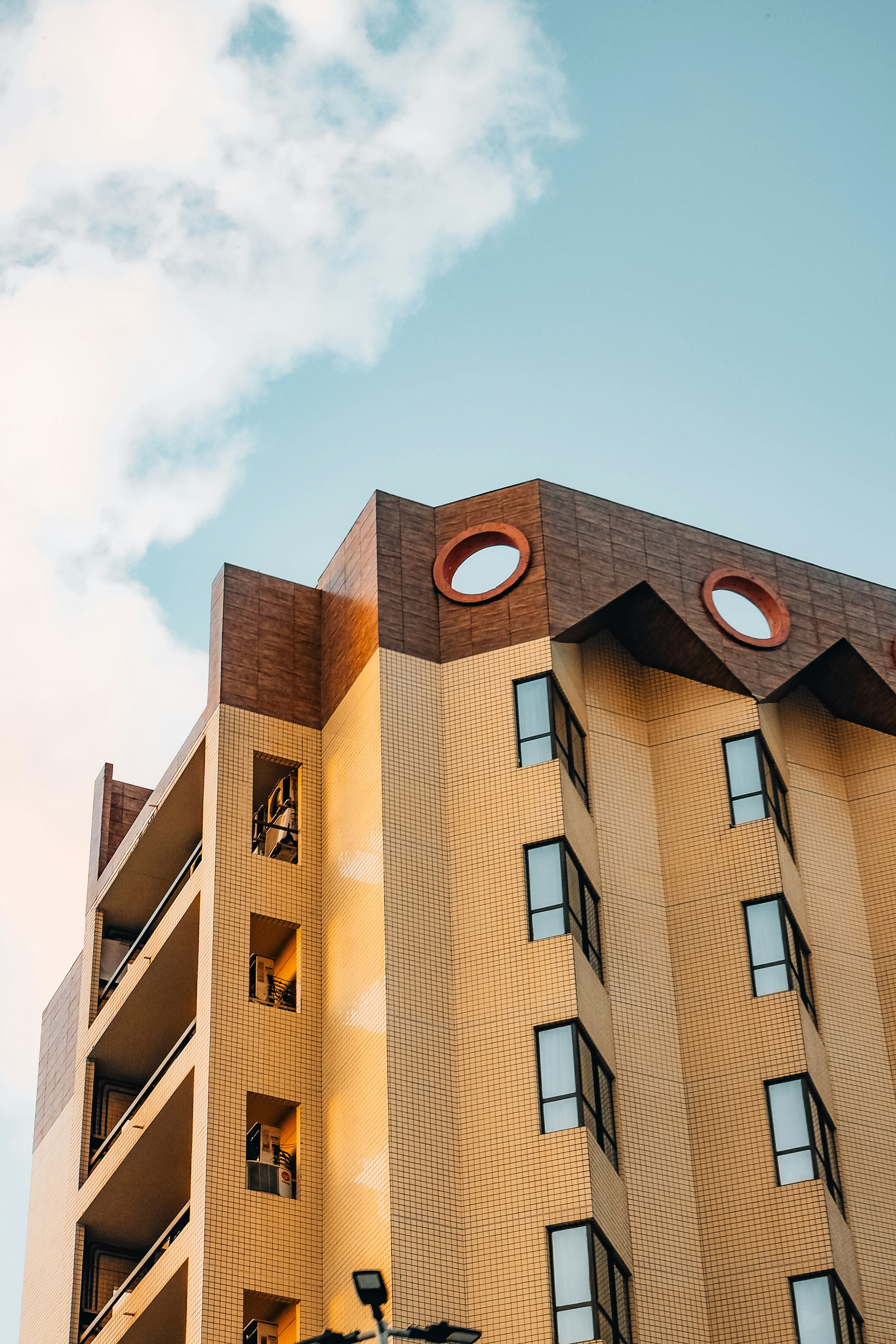 Vertical Prism: Sunlit Facade of a Modern Corner Building