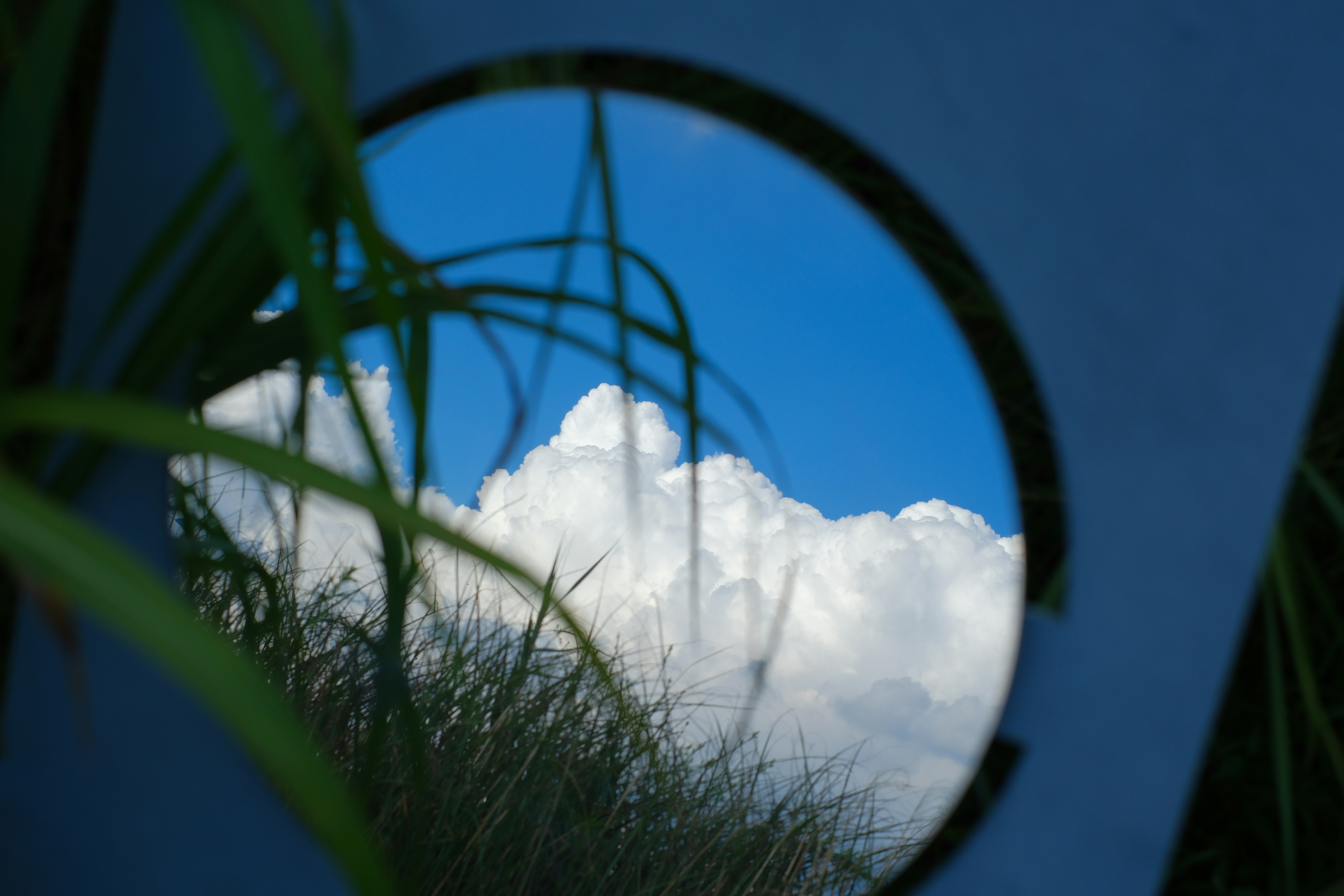 Circular Portal: Cloud Peak Inside a Blue Frame