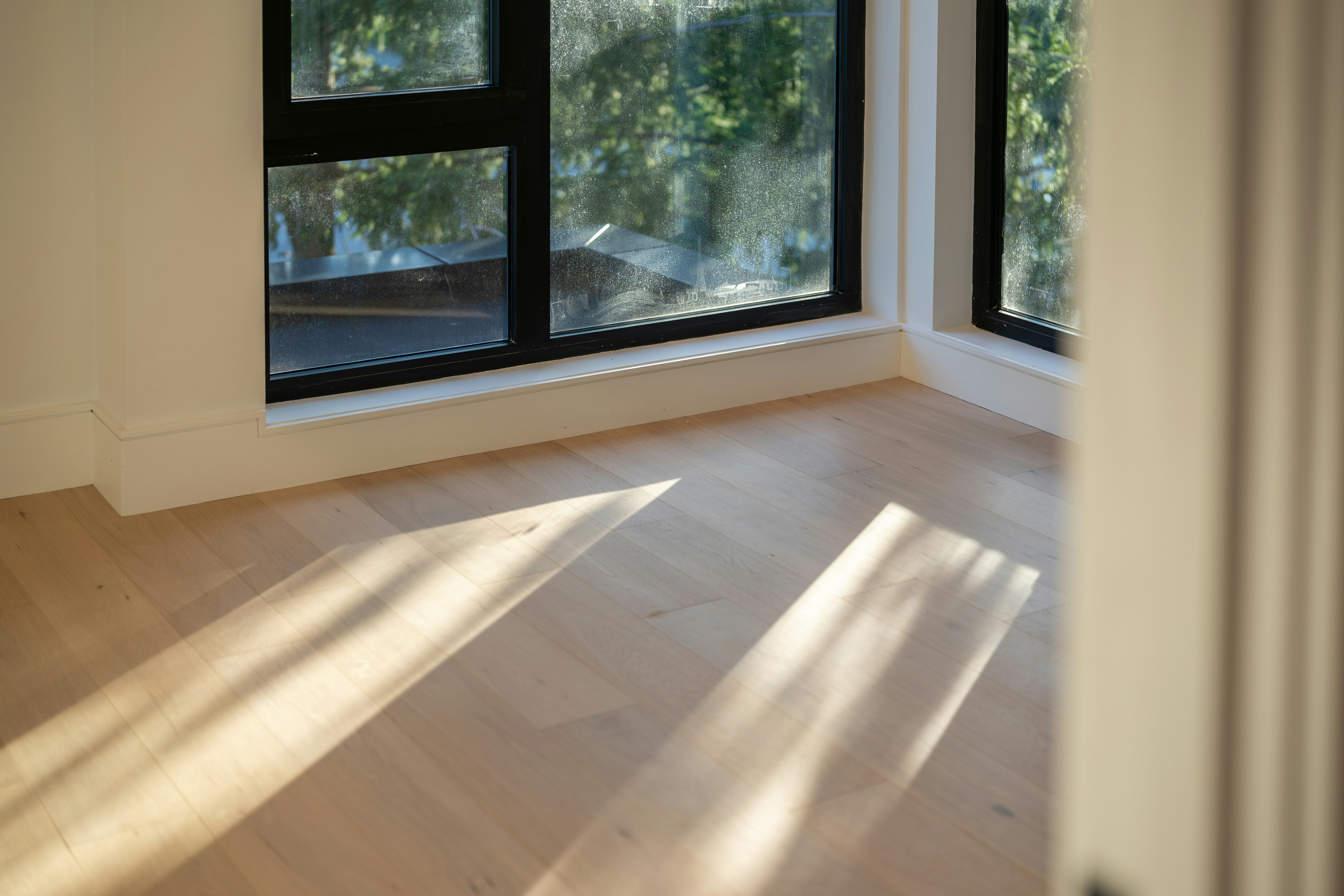 Sunlit Corner: Quiet Morning Light Across Bare Hardwood