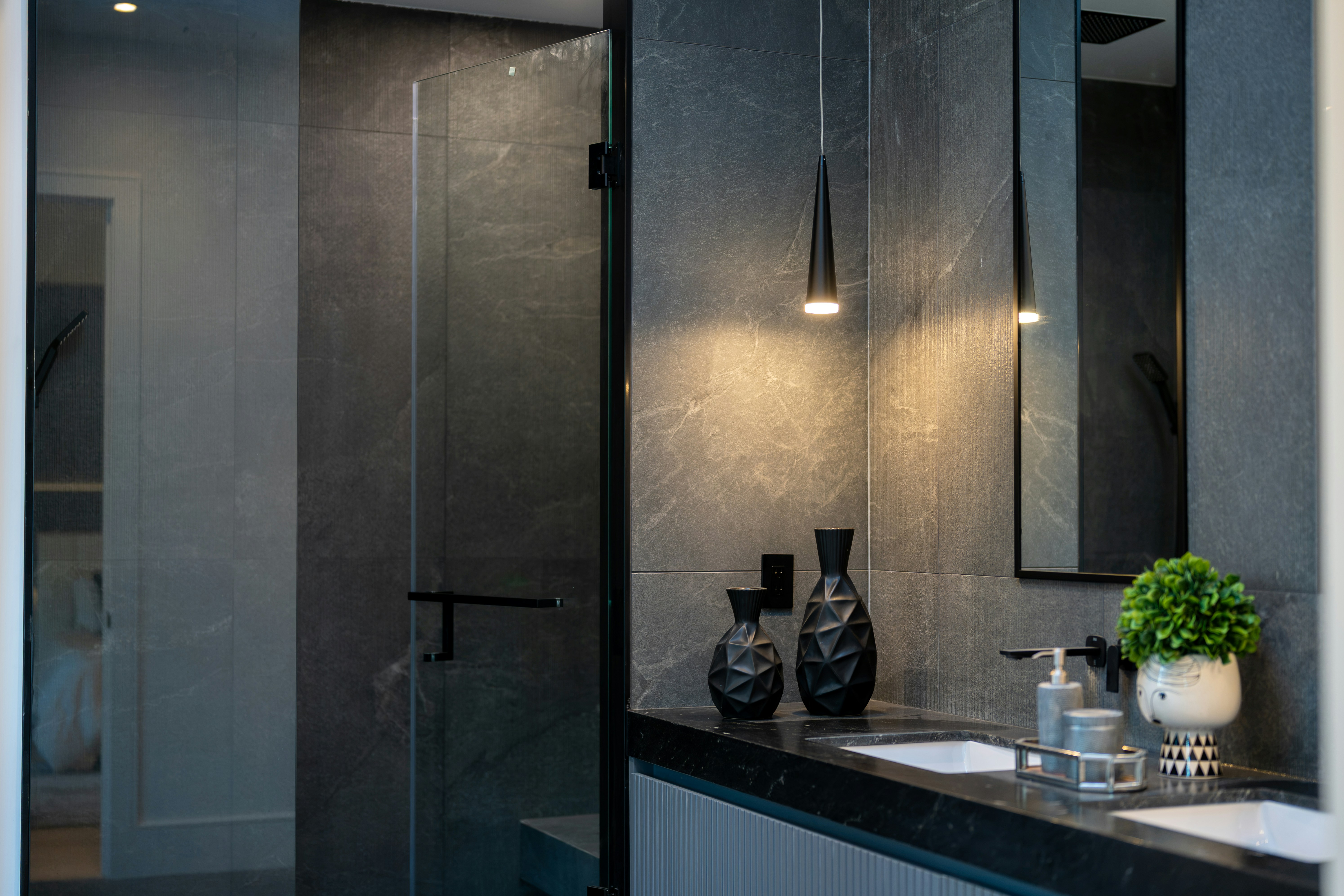Minimalist bathroom vignette with sculptural accents at vanity