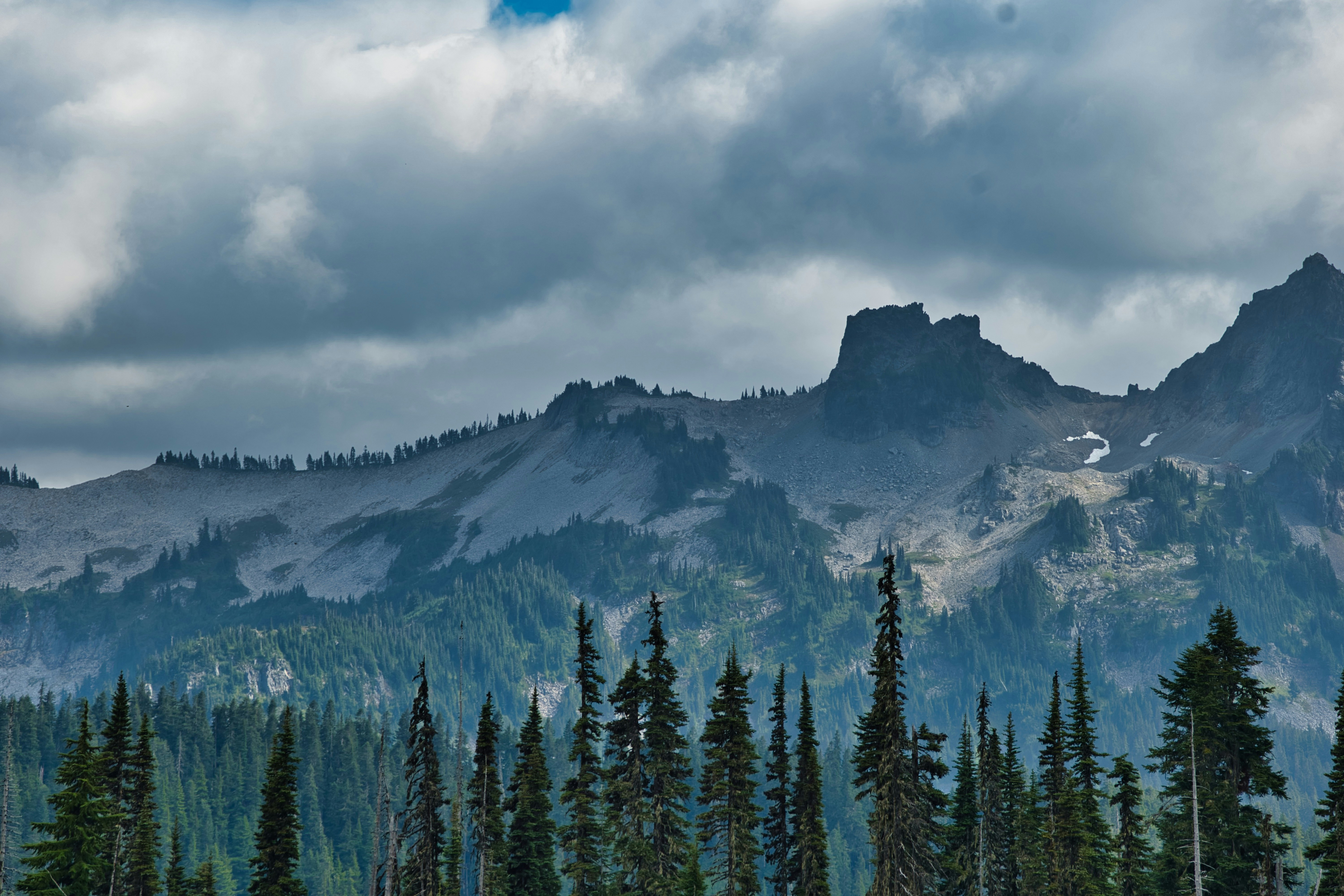 Snow-chiseled ridge under brooding clouds