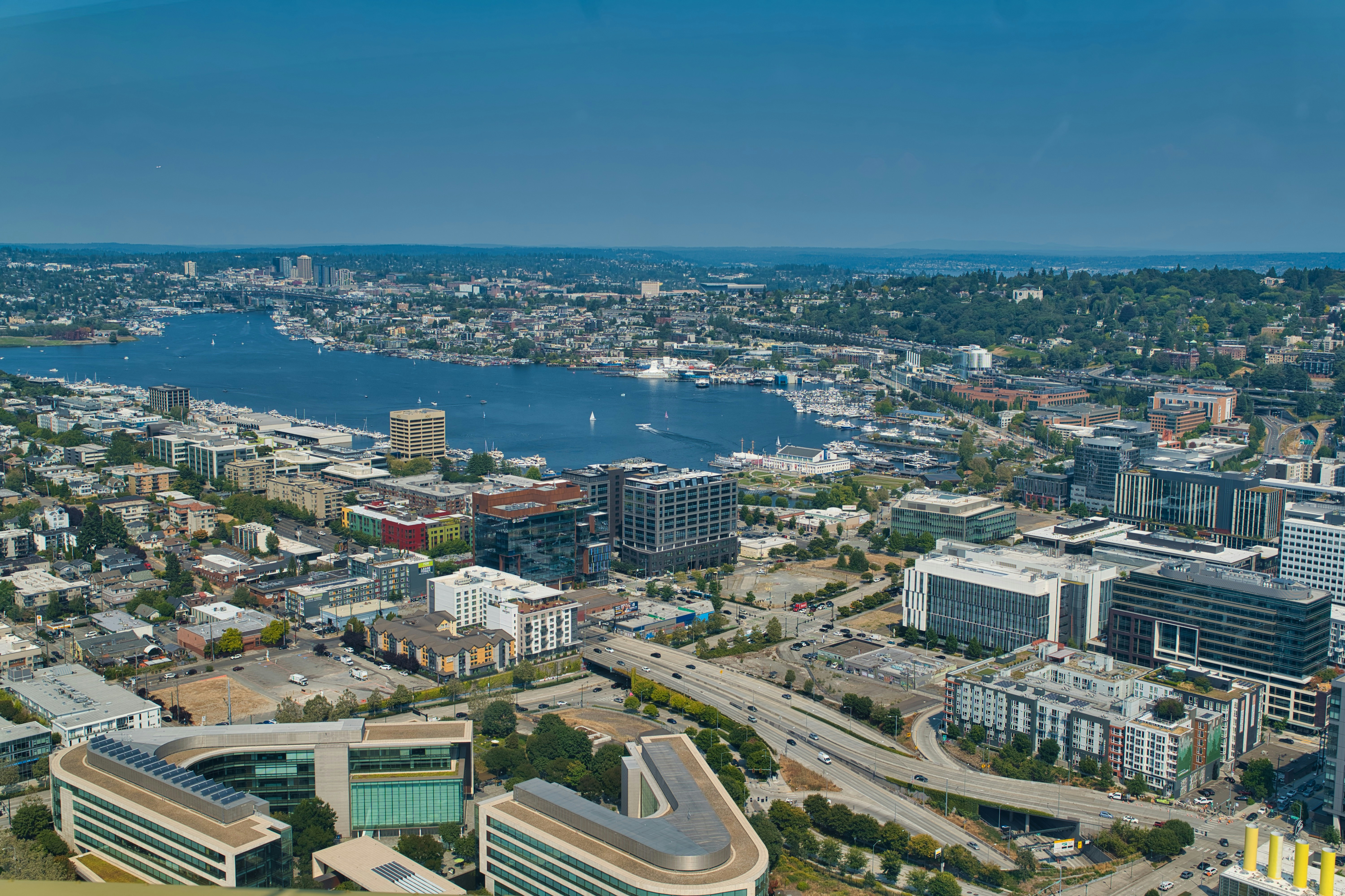 Aerial panorama over a sunlit urban harbor