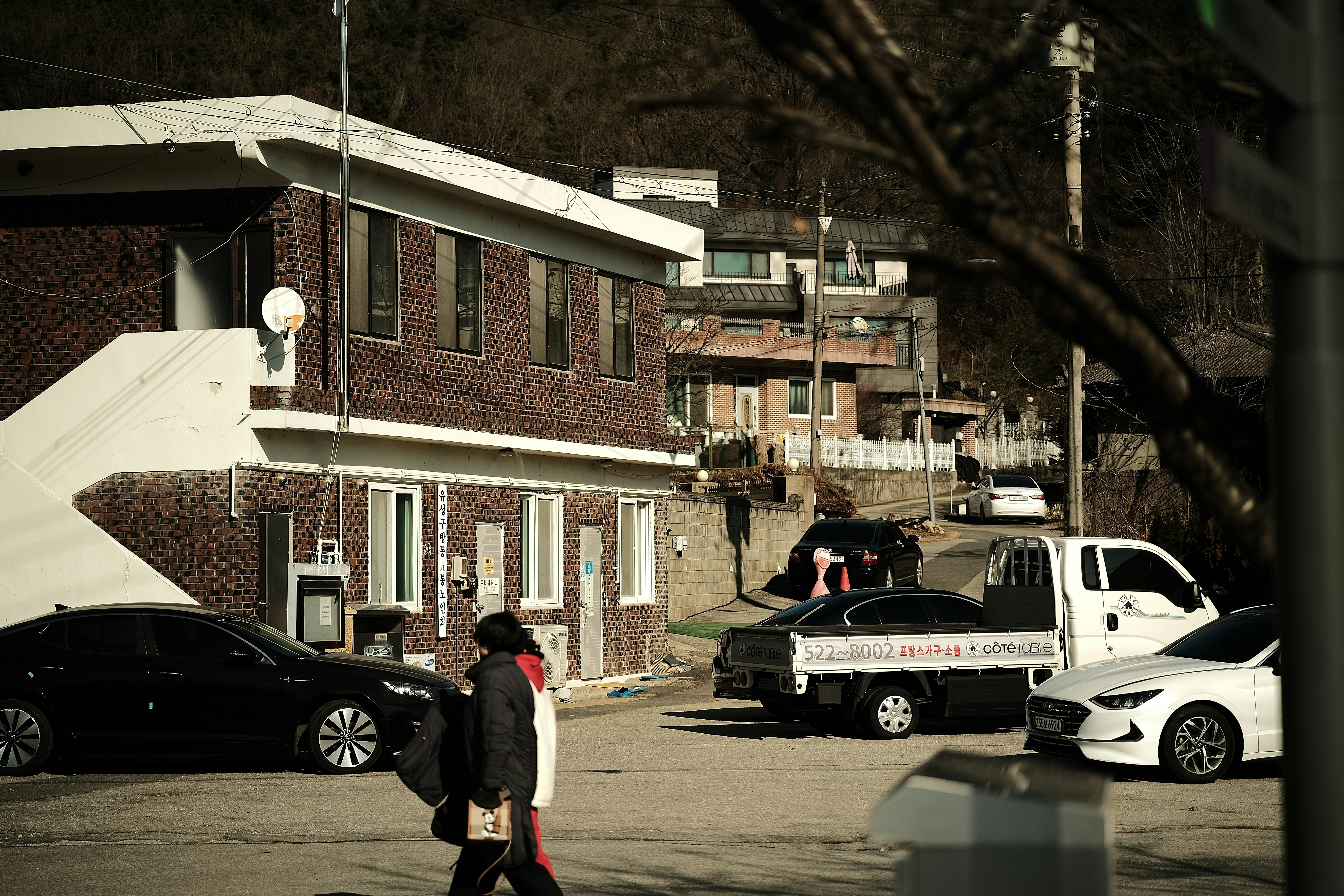 Residents and vehicles in a quiet urban street