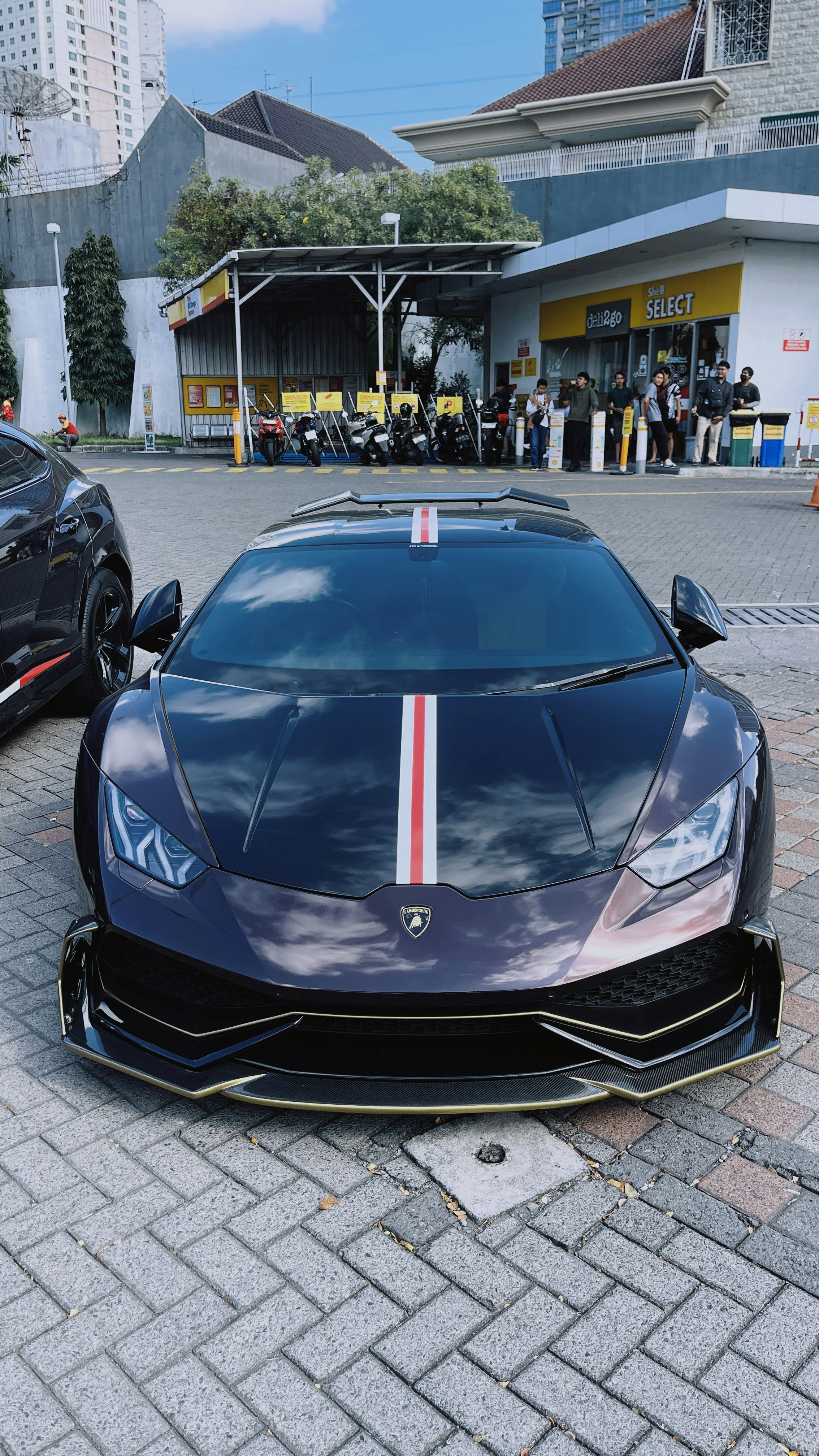 Armored Dream: A Dark Blue Lamborghini Strikes a Modern Street Scene