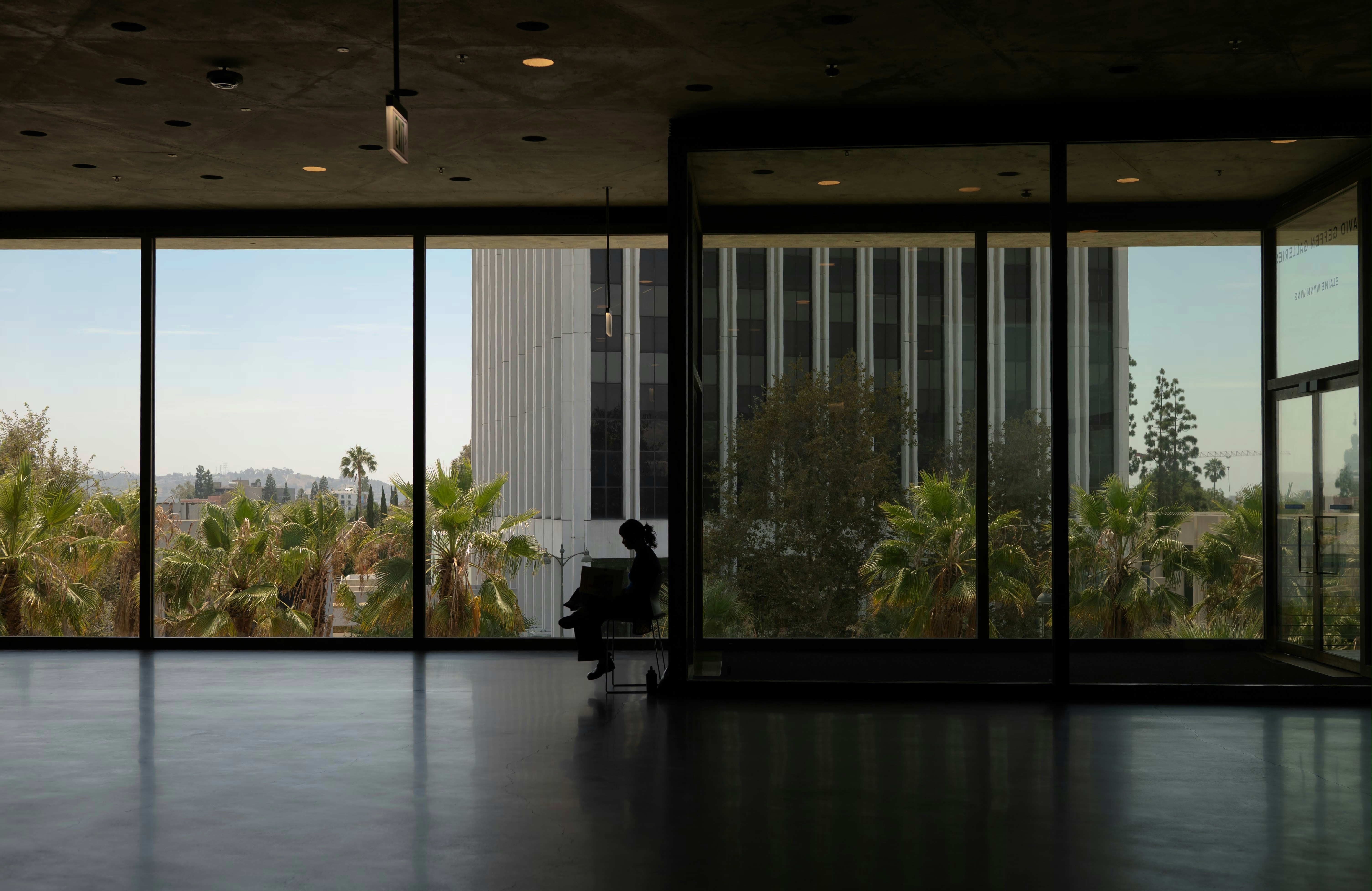 Silhouetted Operator in a Sunlit Atrium
