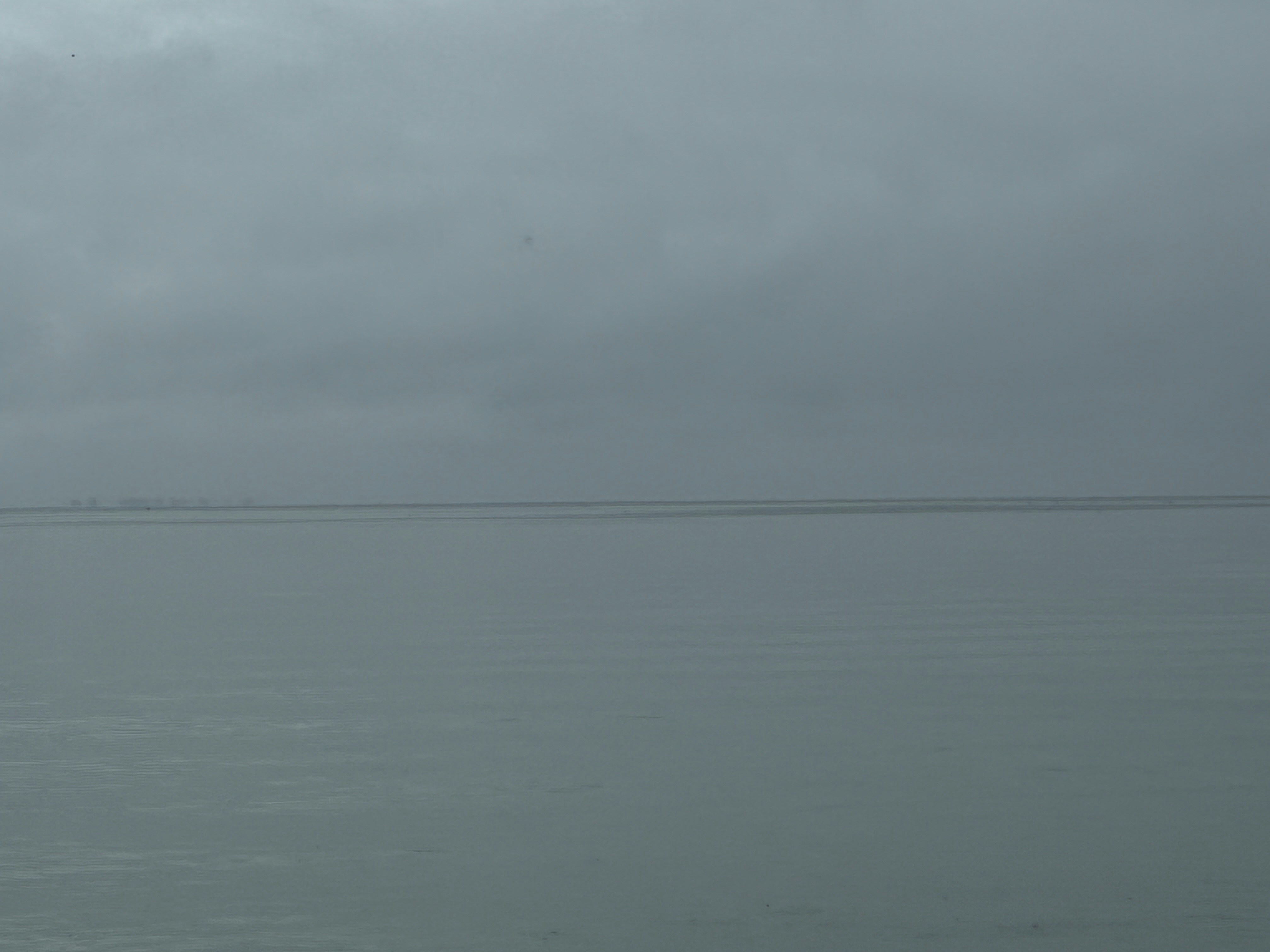 Mist at the Horizon Over a Calm Inland Sea