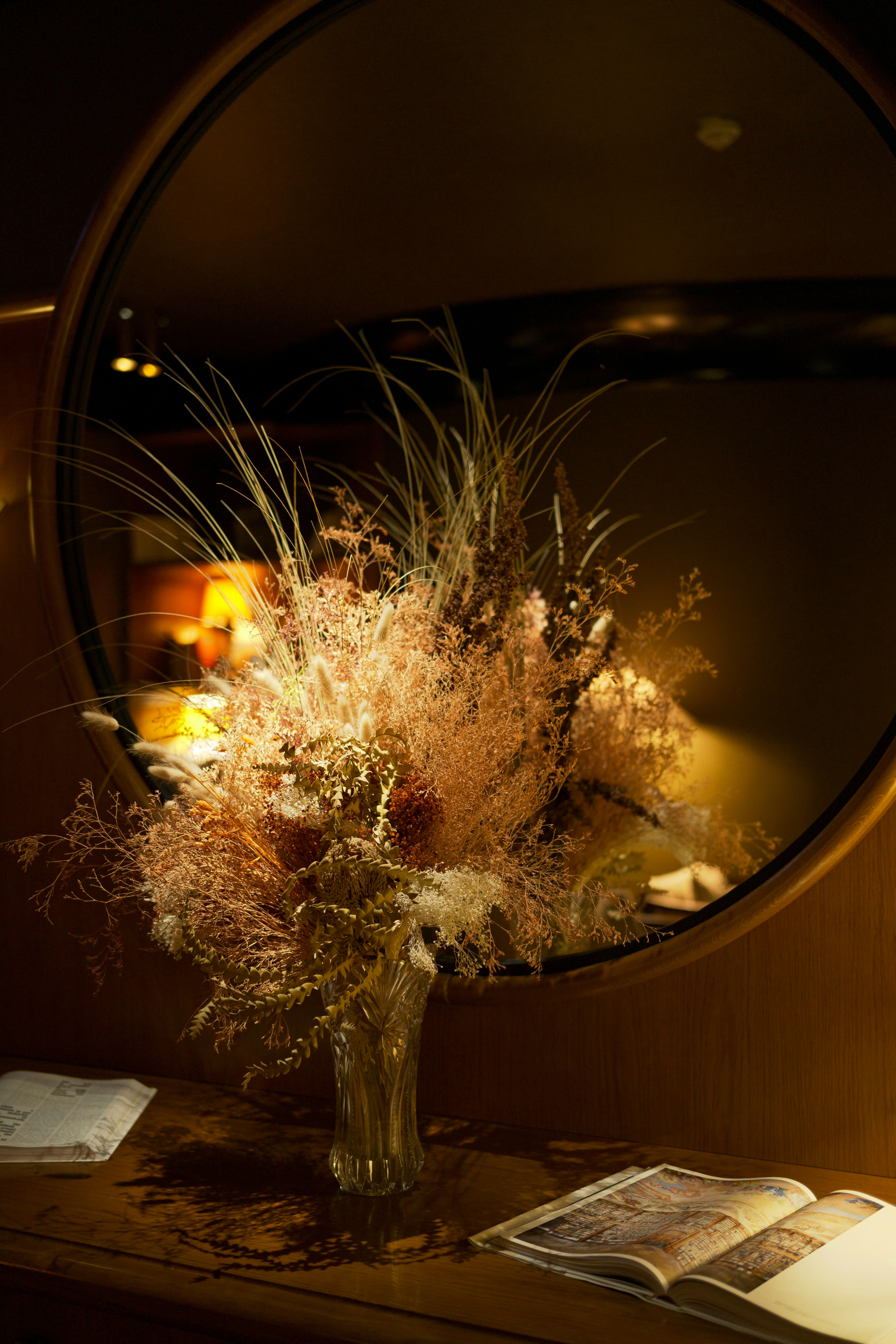 Warm Centerpiece Reflections in a Round Mirror