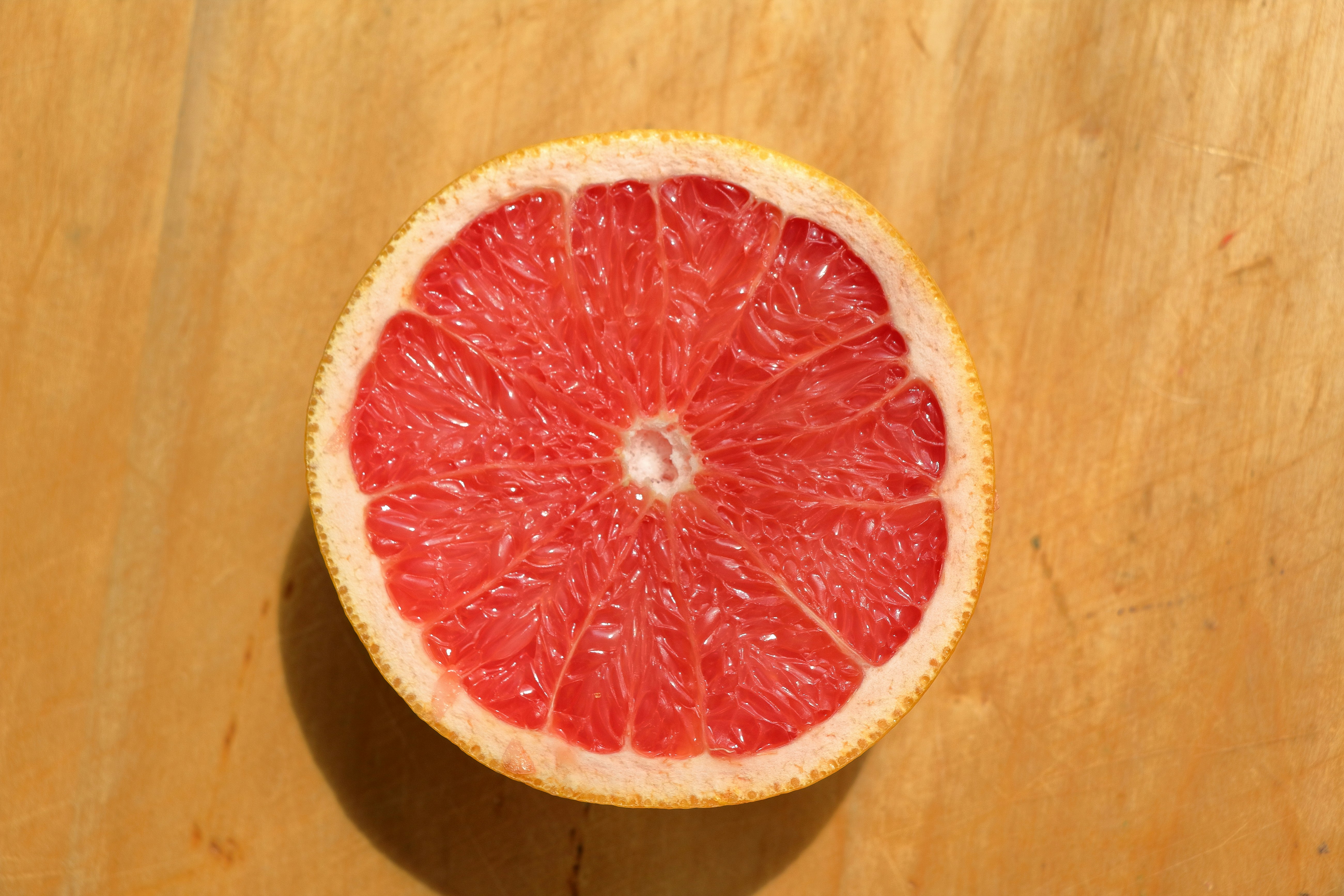 Grapefruit Spotlight: A Citrus Slice on Warm Wood