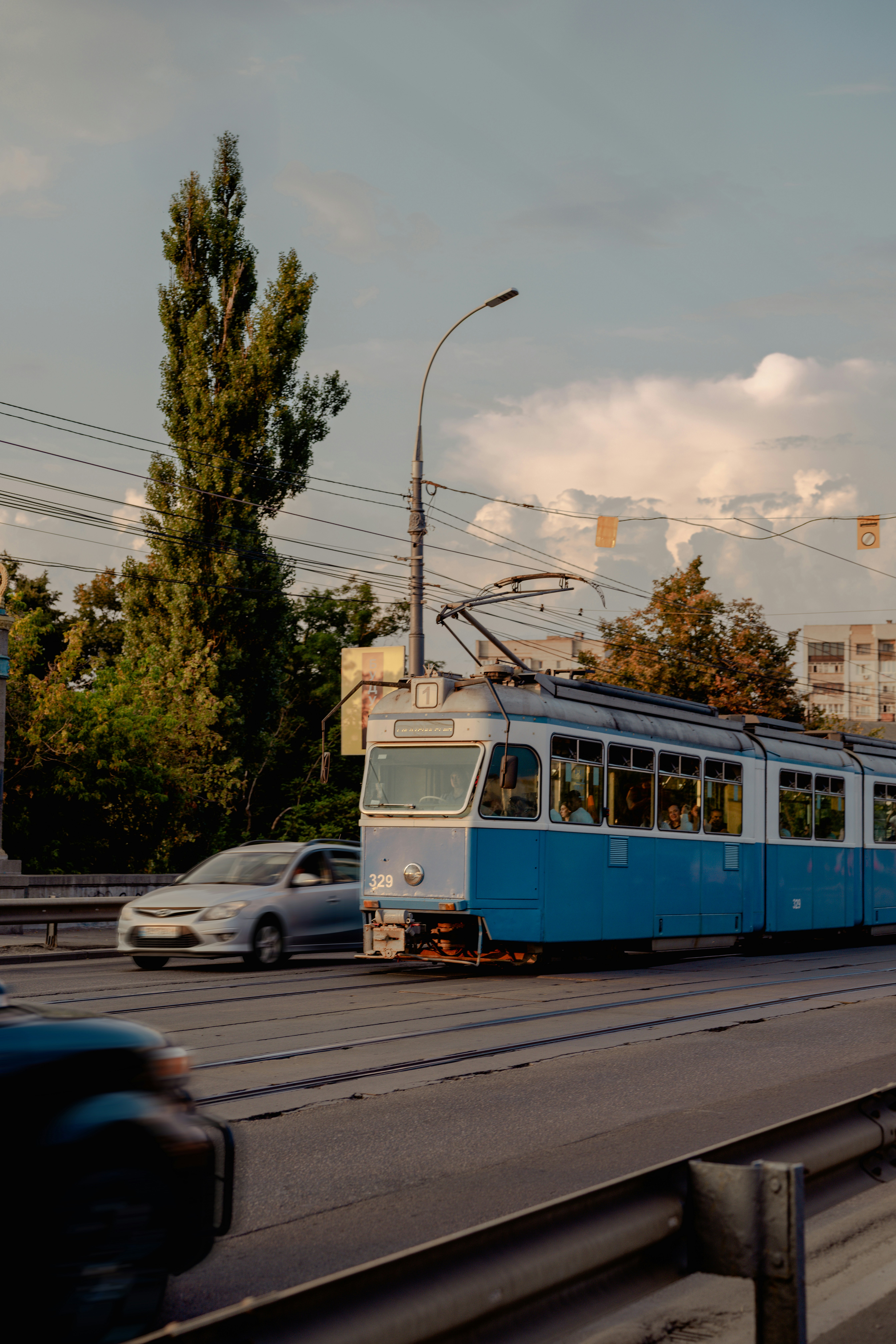 Blue Tram in Rush Hour: Neon Voice of the City
