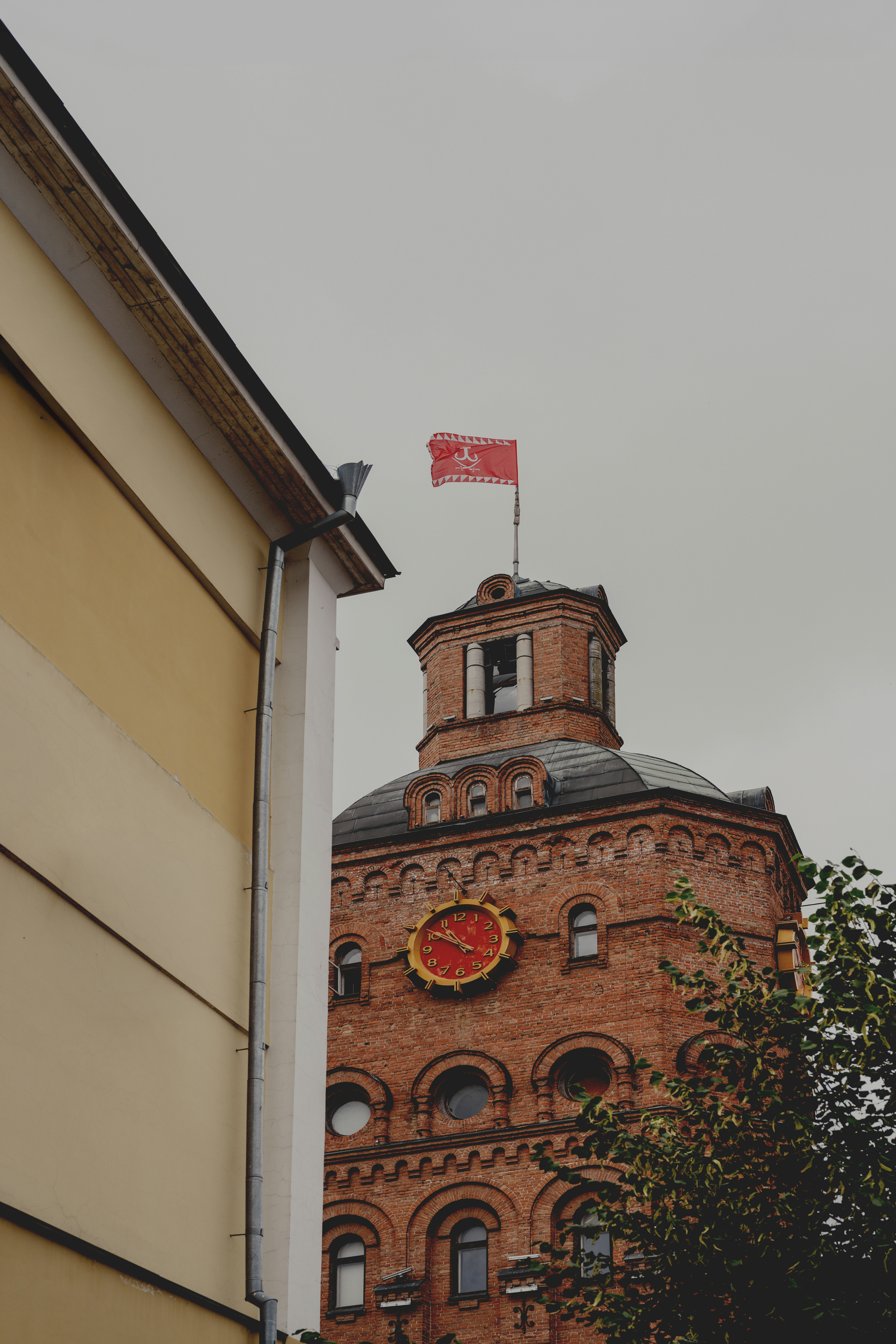 Brick Clock Tower Under a Pale Sky