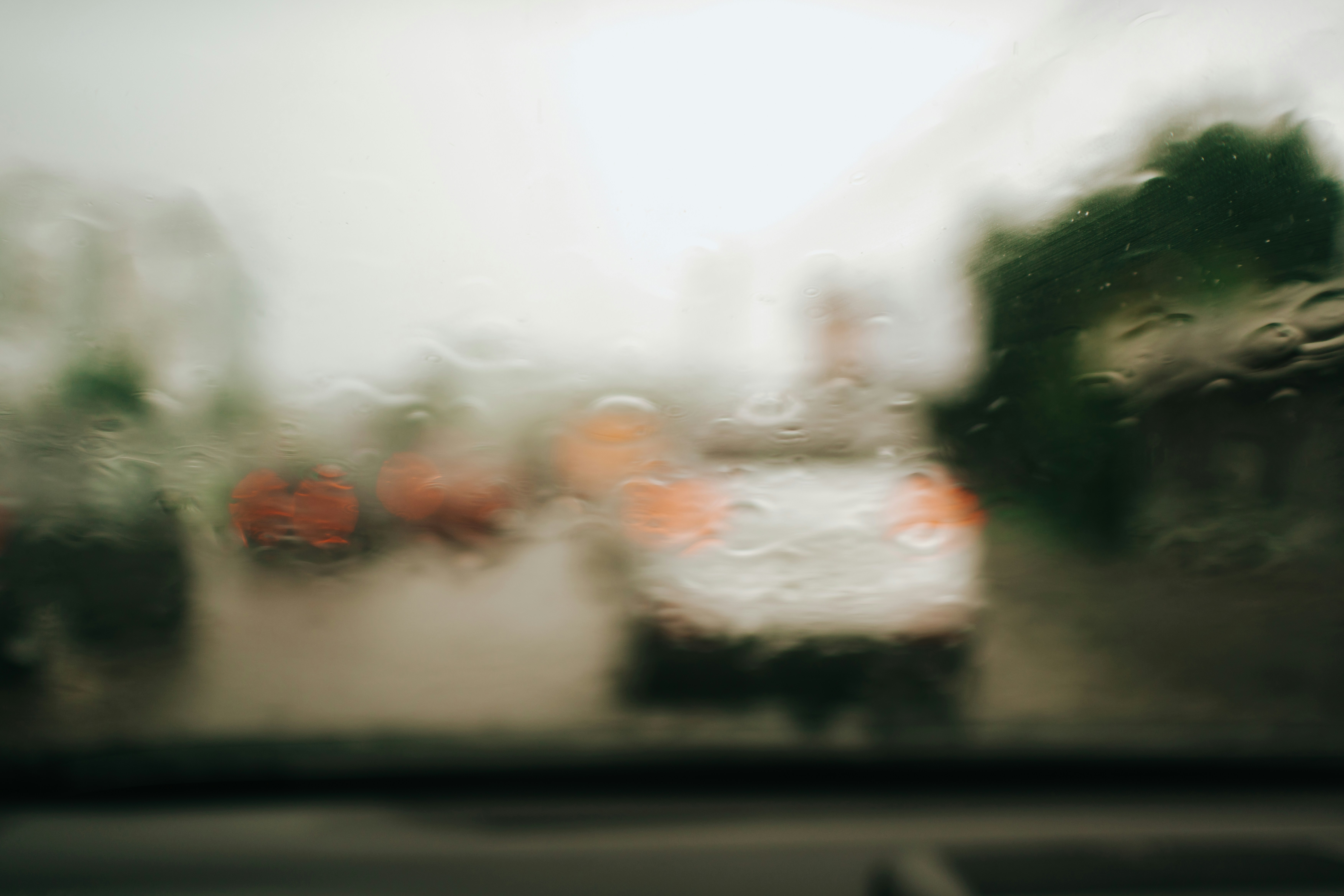 Blurred Rain on the Path: City Lights Through a Windshield