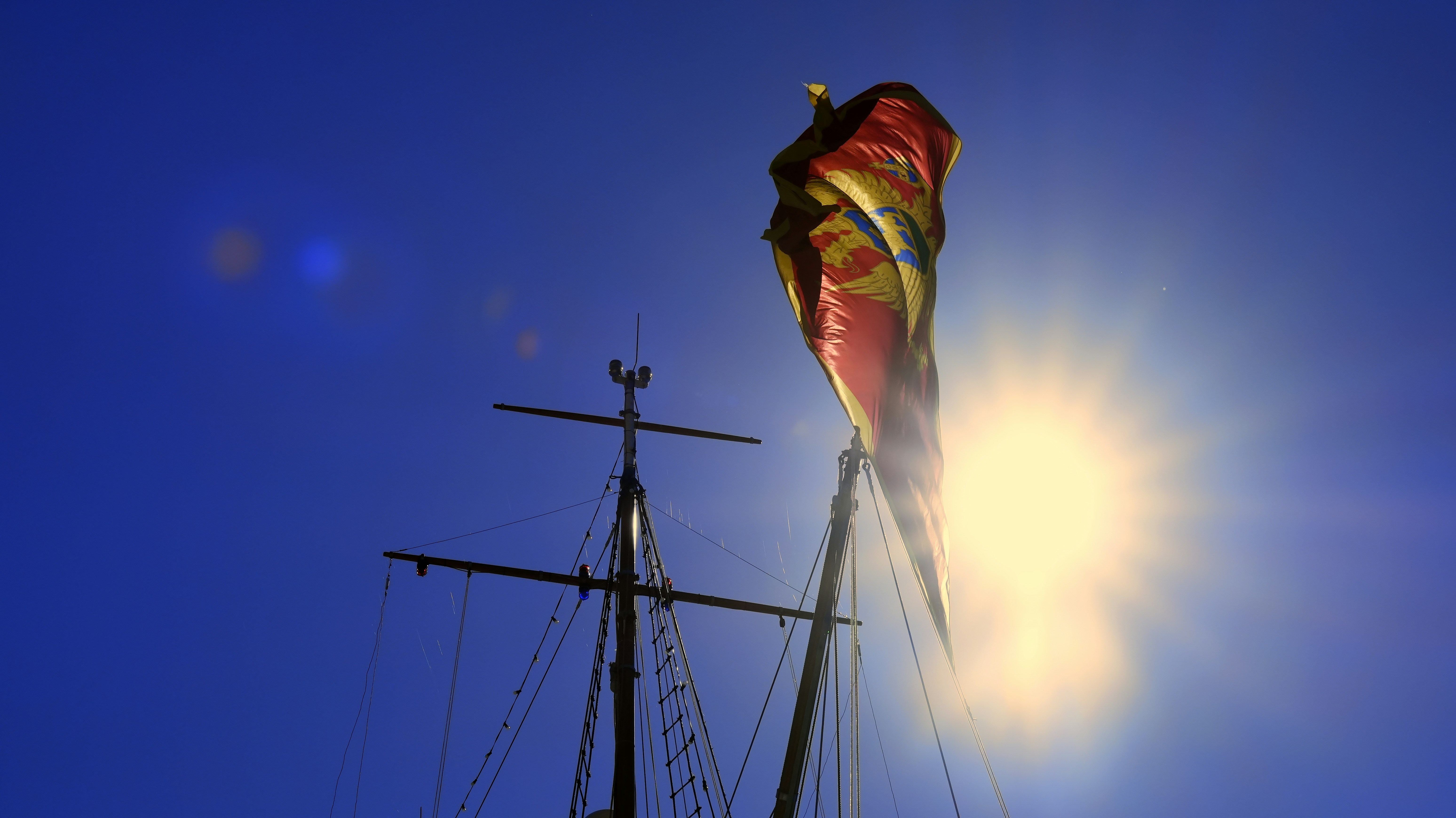Sailing Banner and Rigging Against a Bright Horizon