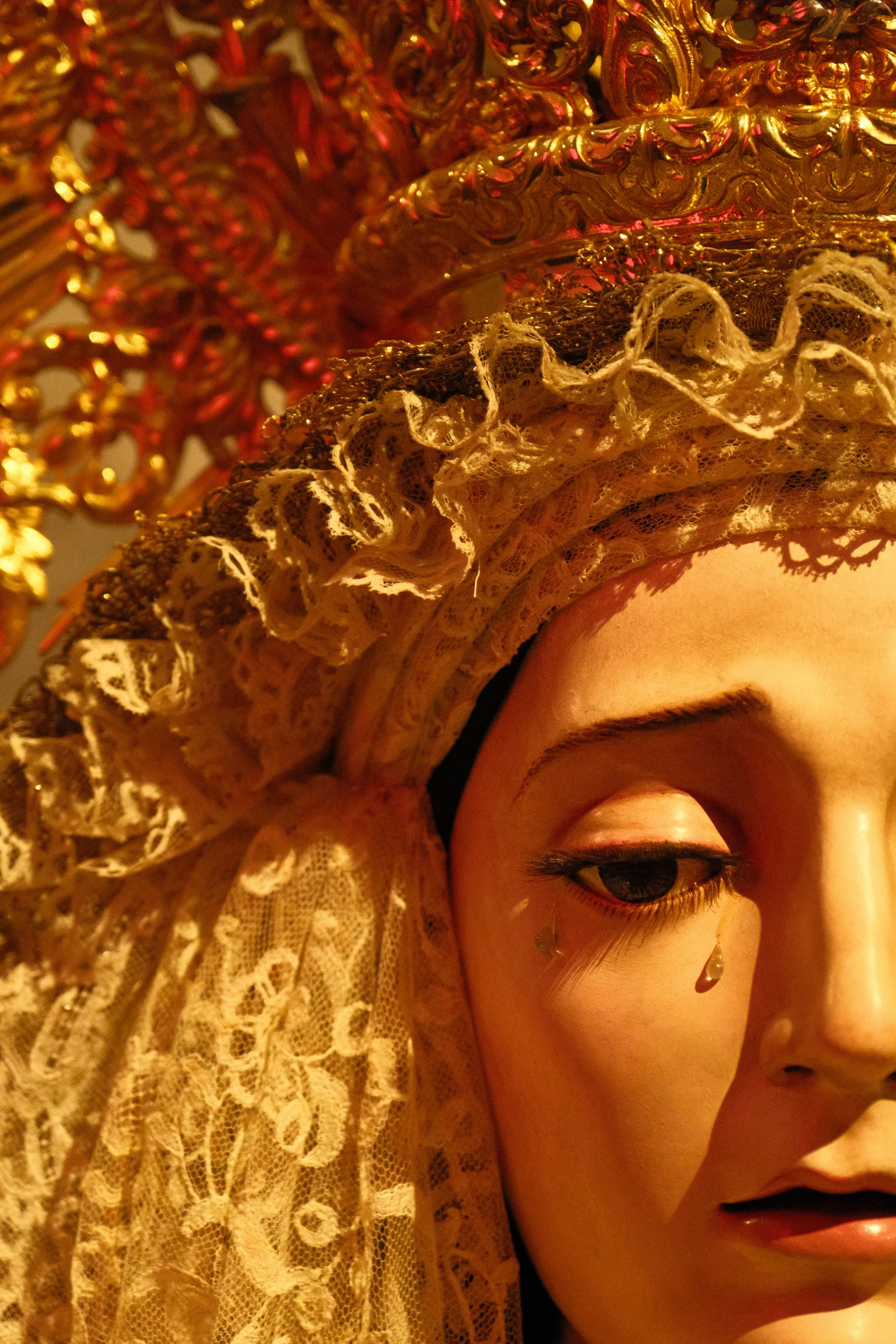 Golden Halo and Teardrop: Close-Up of a Luminous Sacred Face