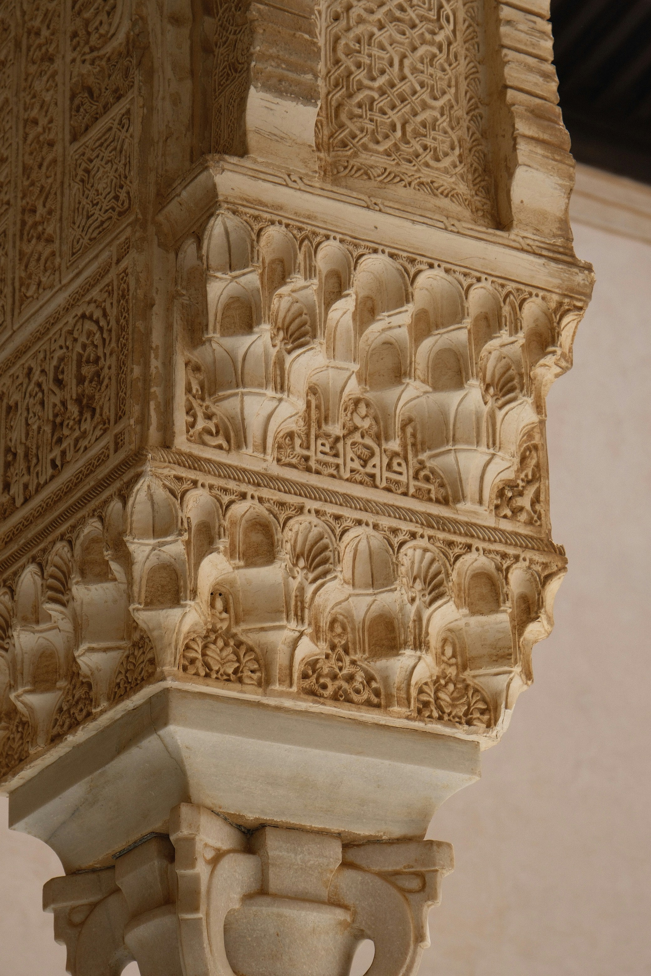 Carved stone arcade: intricate vaulting and repeated motifs in warm-toned relief