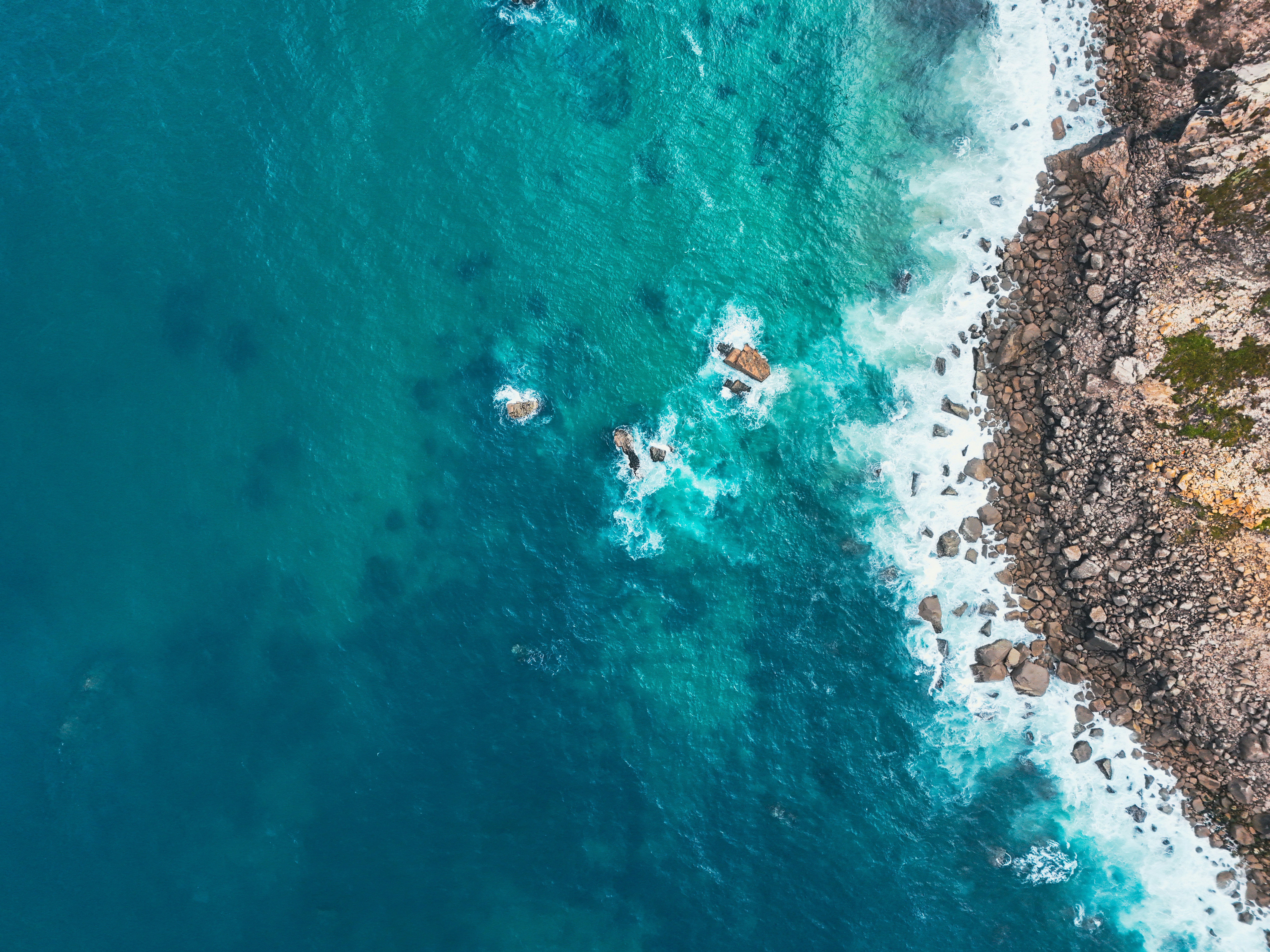 Turquoise Foamy Edge: Aerial View of Cliffline and Shore