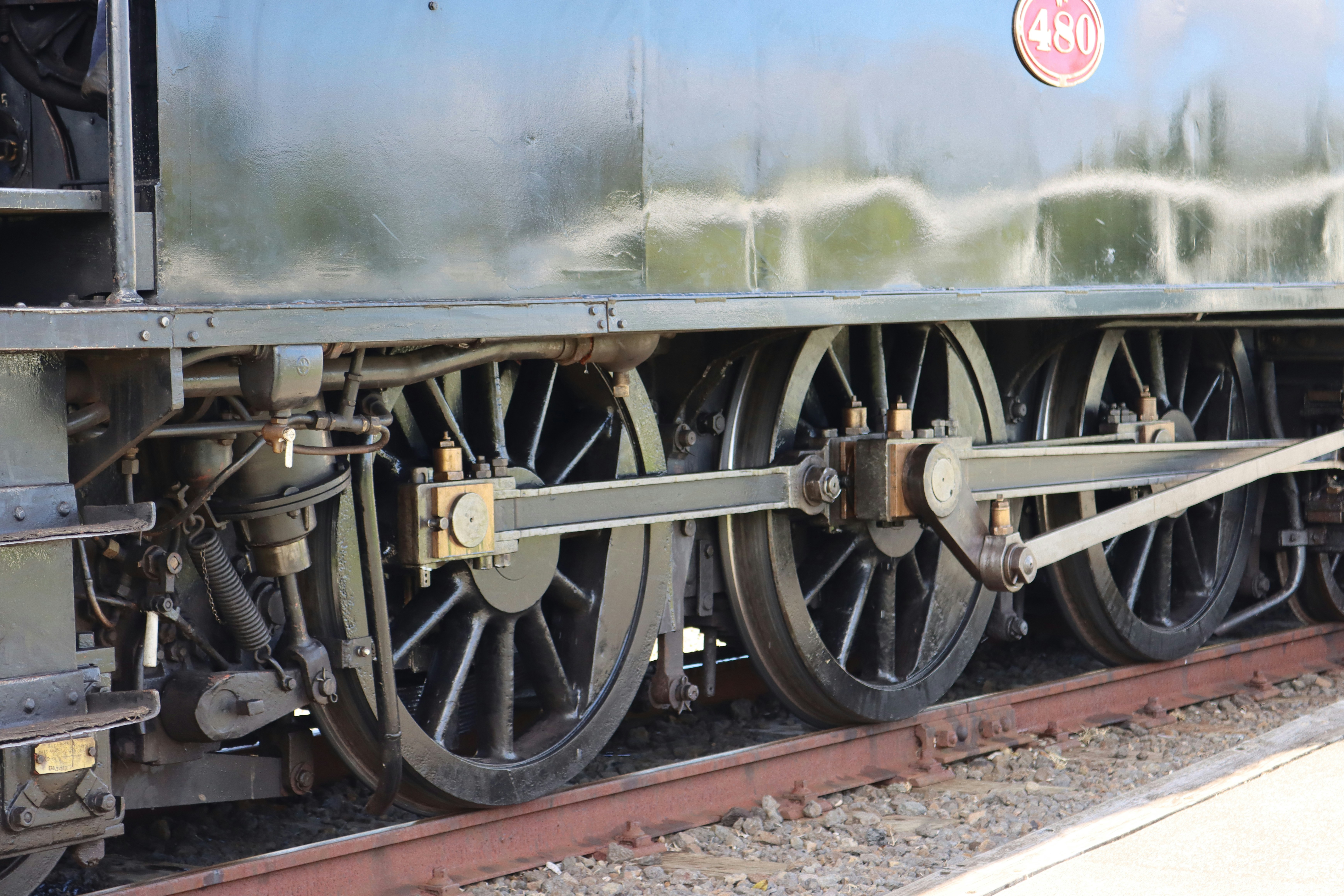 Steely Momentum: Close-up of Steam Locomotive Wheels and Rods
