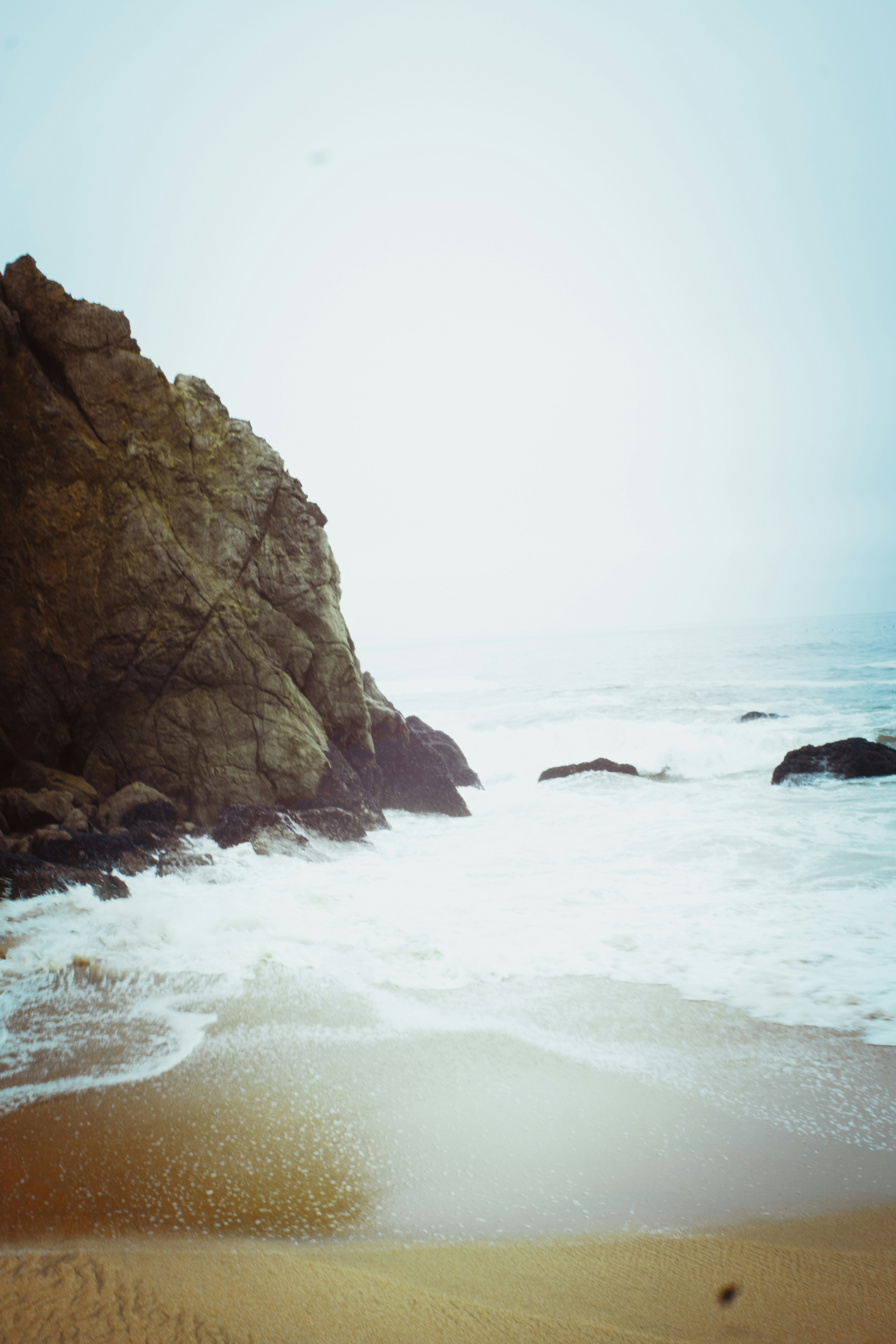 Rugged Cliffs Meet Whispering Shore at Dusk