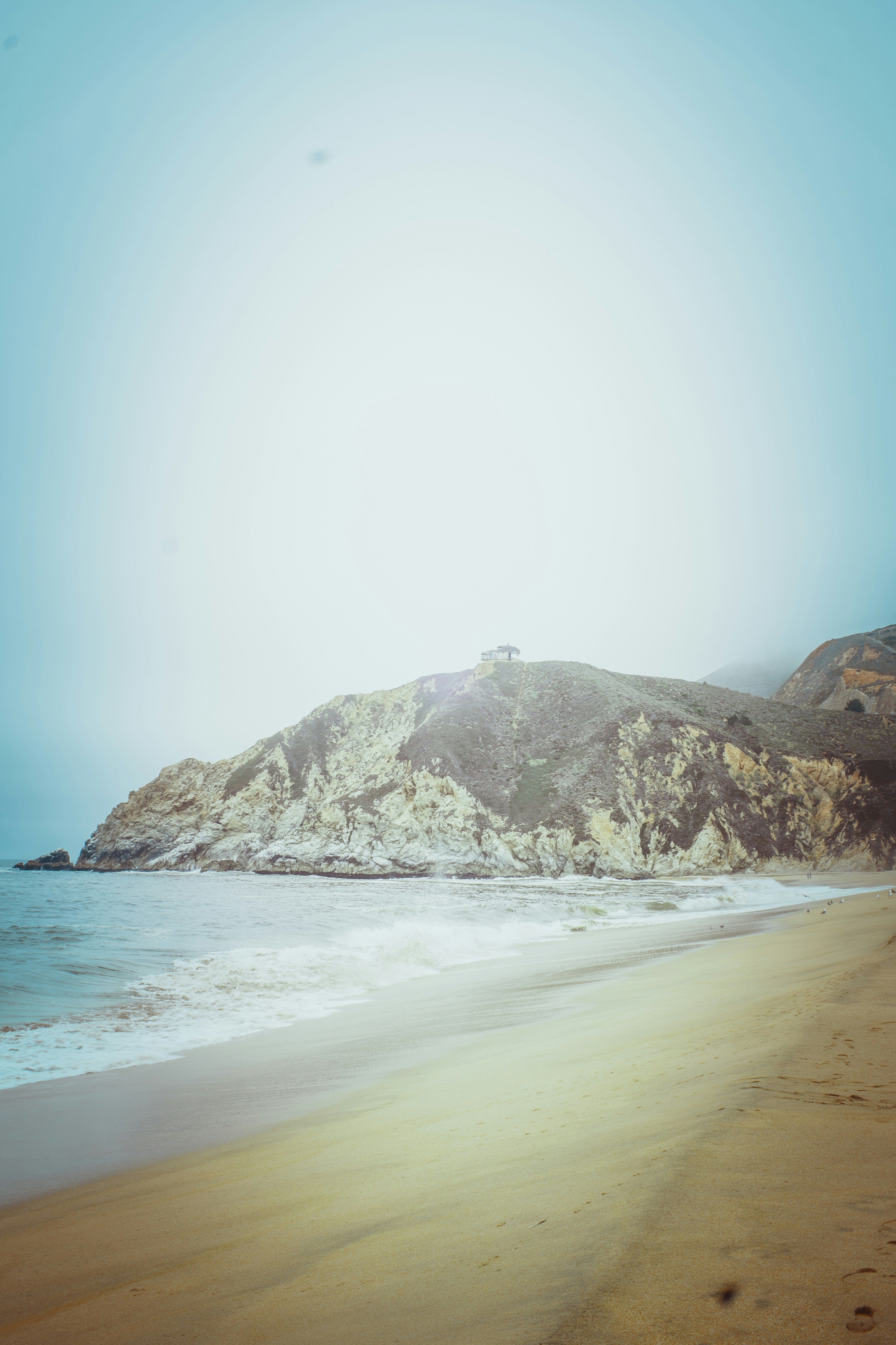 Coastal Promontory at Dusk: A Quiet Beach Beside the Cliff
