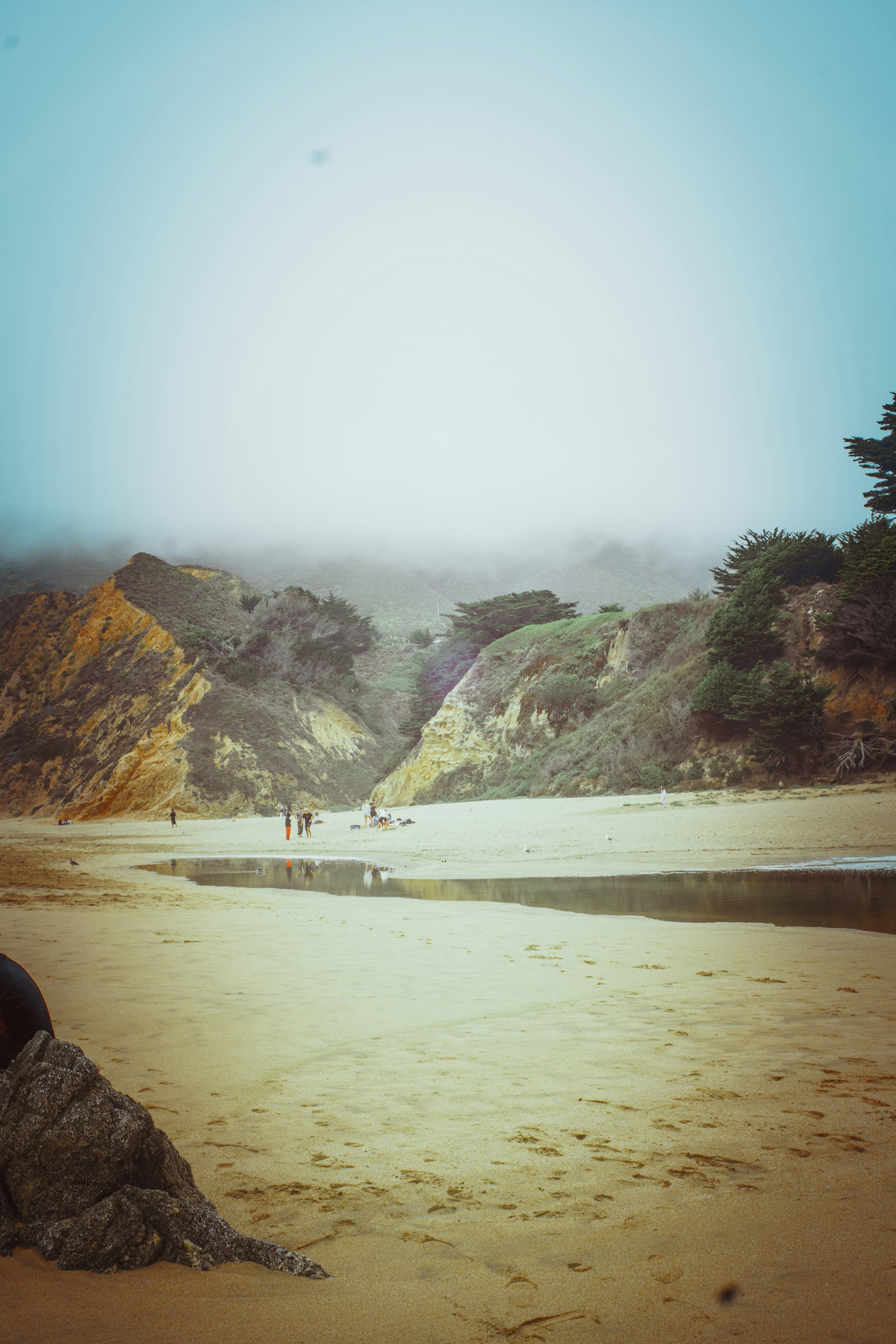 Mist over the Coastal Canyon: A Quiet Beach at Dawn