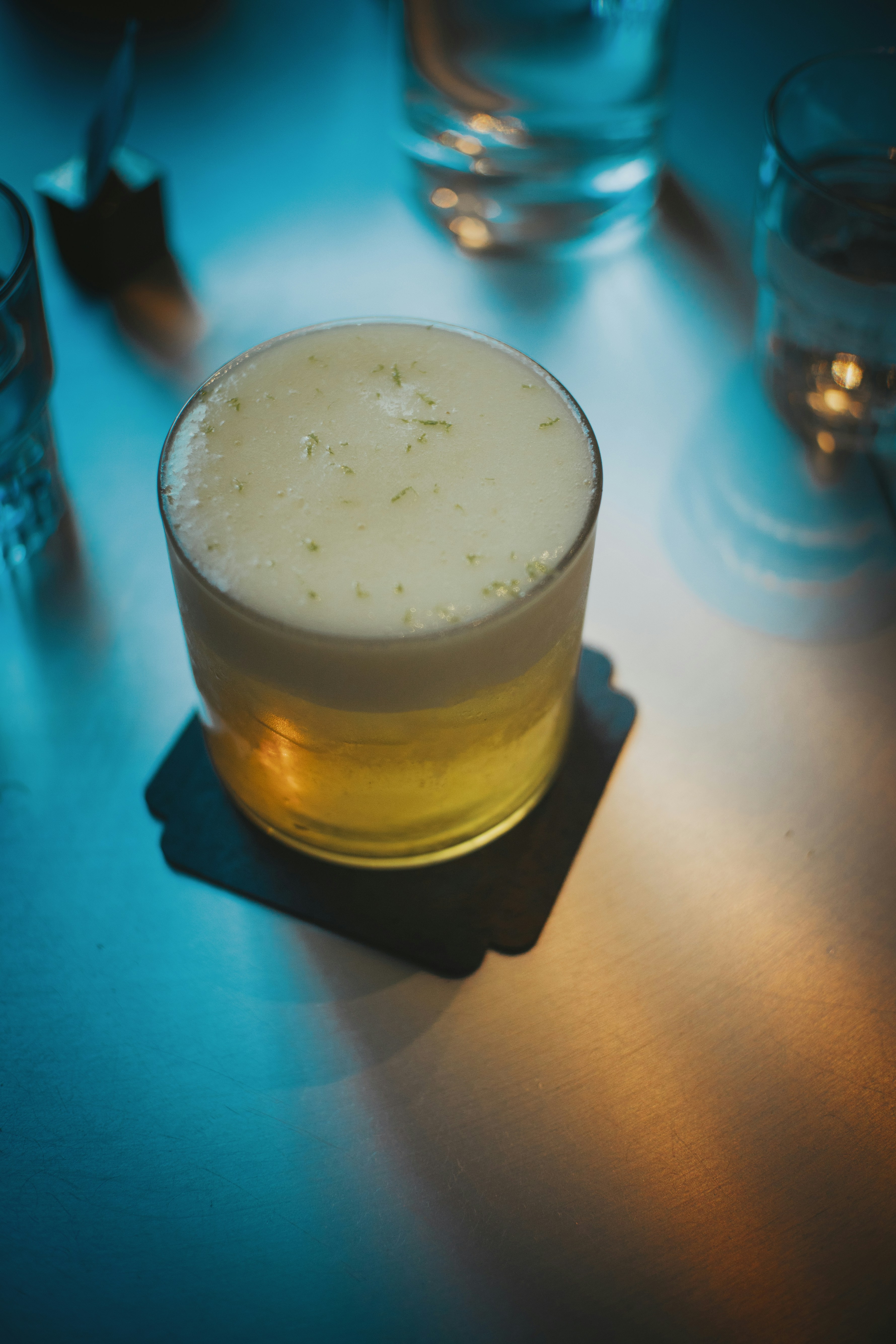 Golden Pint Under Neon Blues