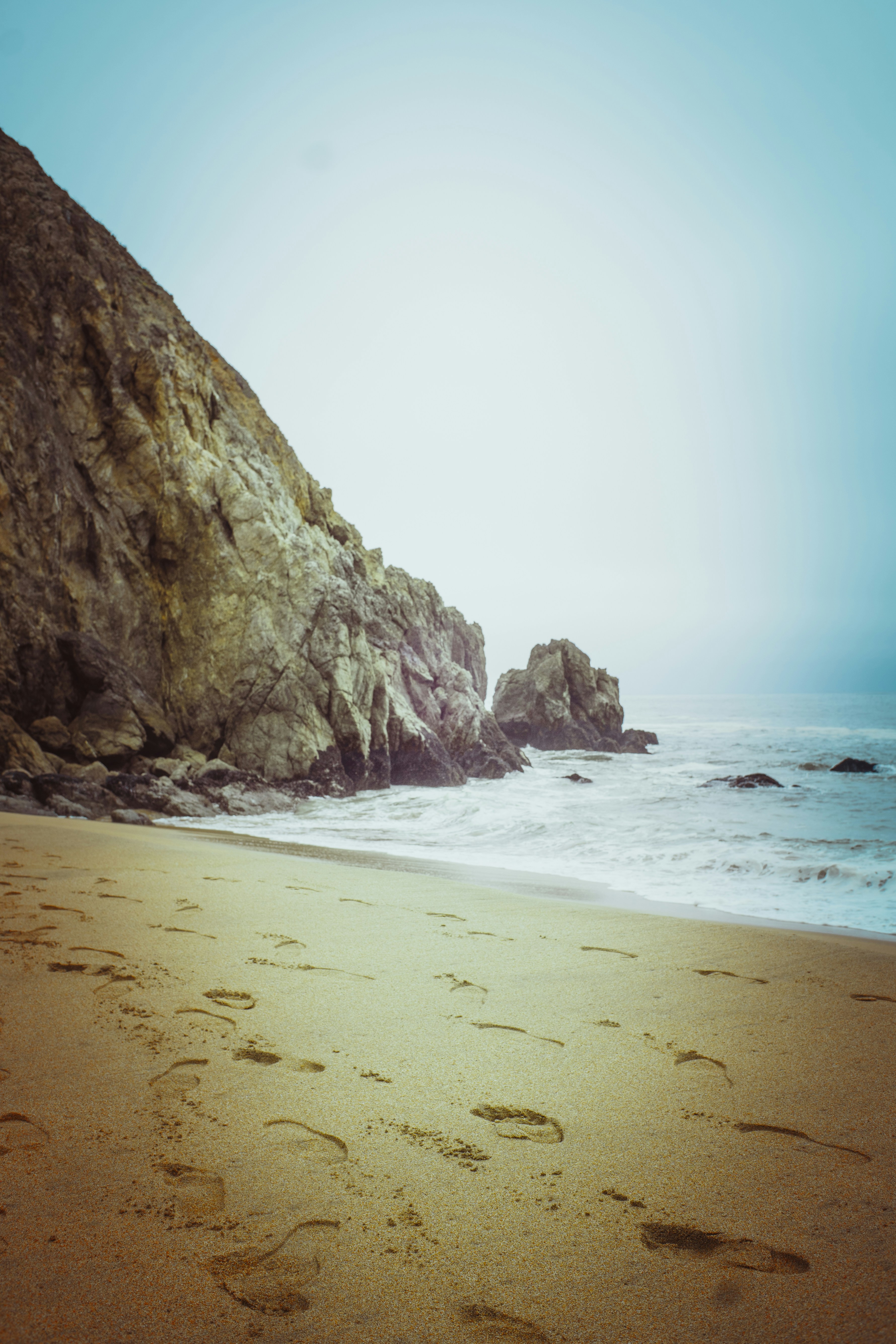 Footprints Along the Cliffside Shore at Quiet Dusk