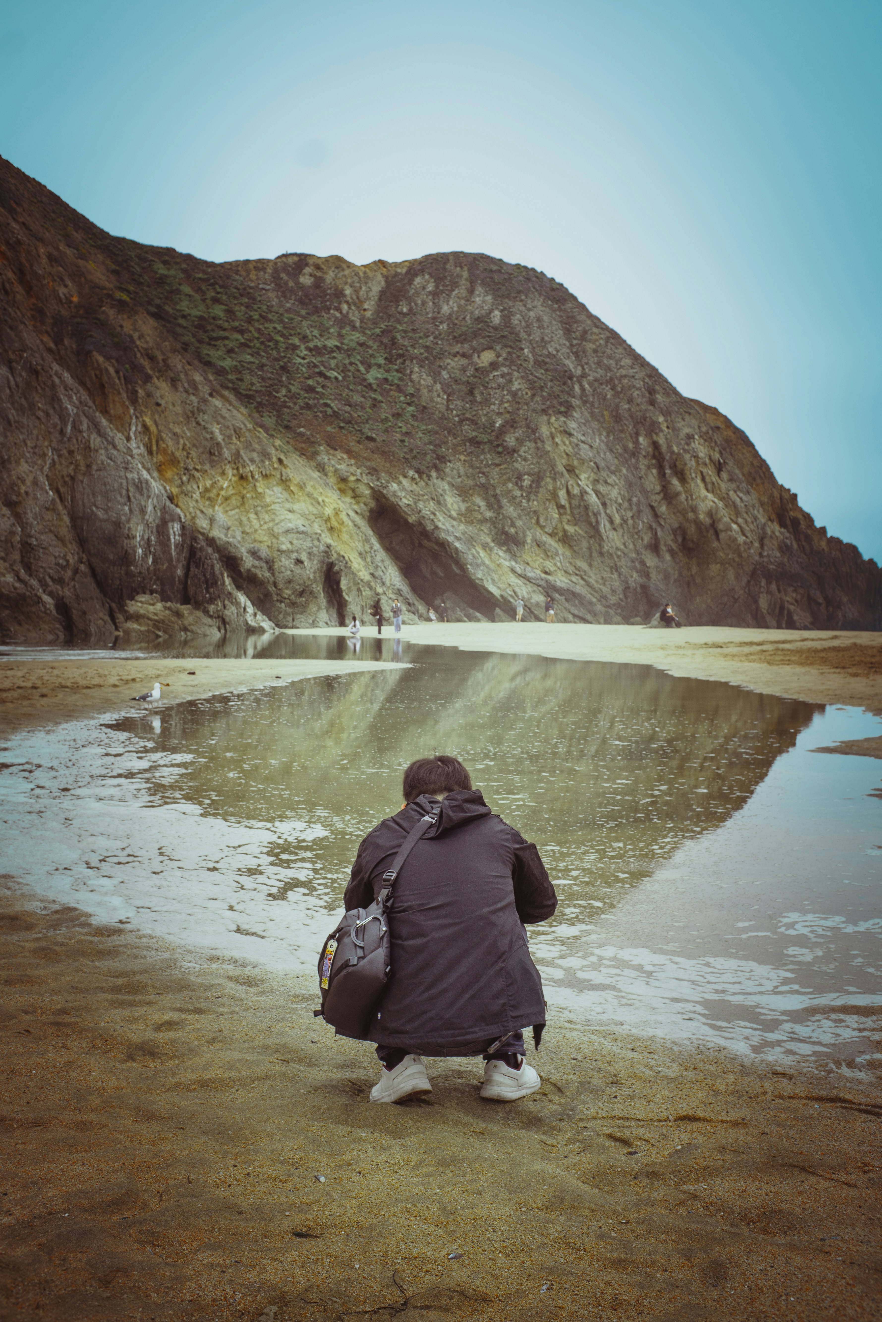 Crouched Photographer at the Tidal Mirror