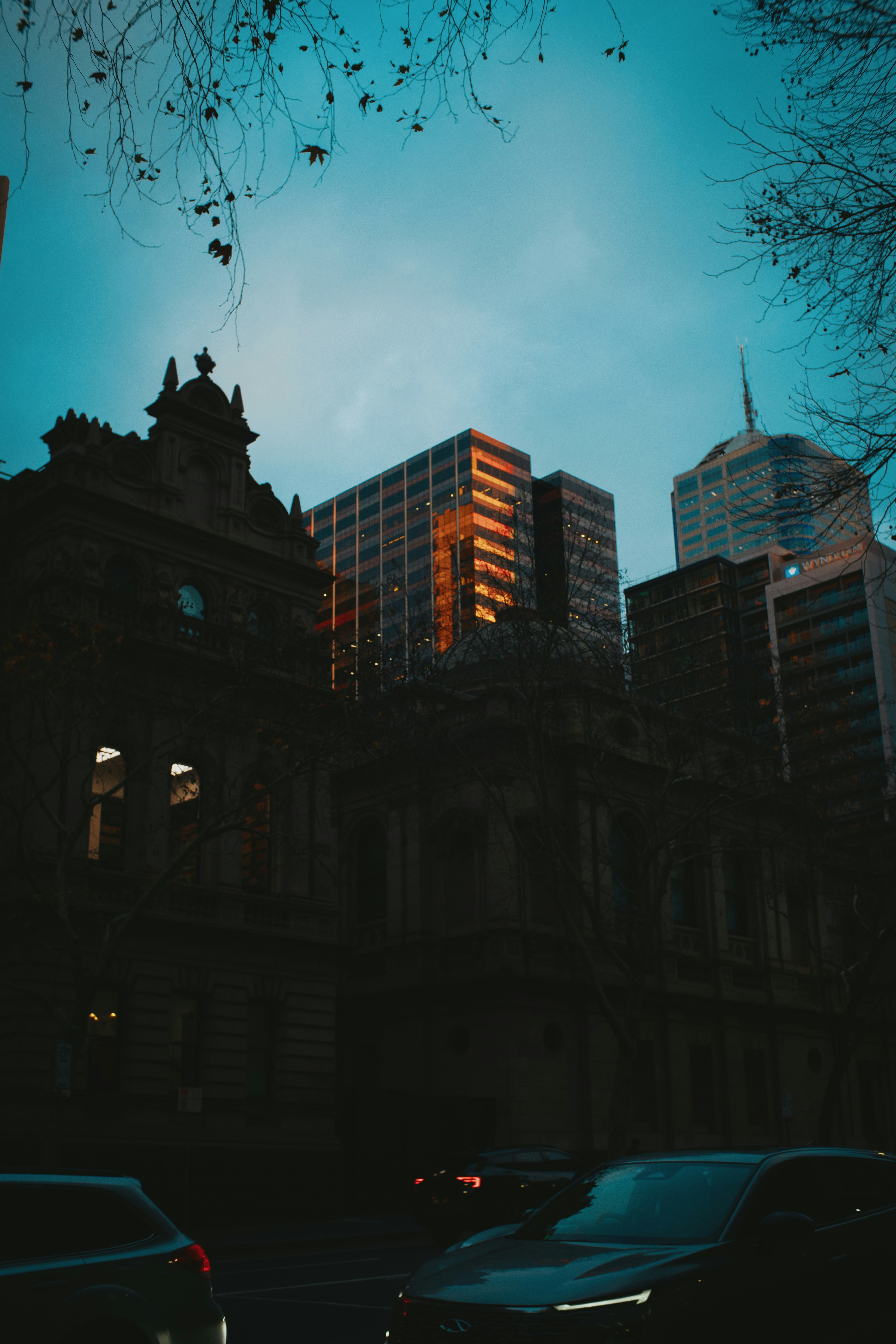 Skyline silhouettes at dusk over a historic facade